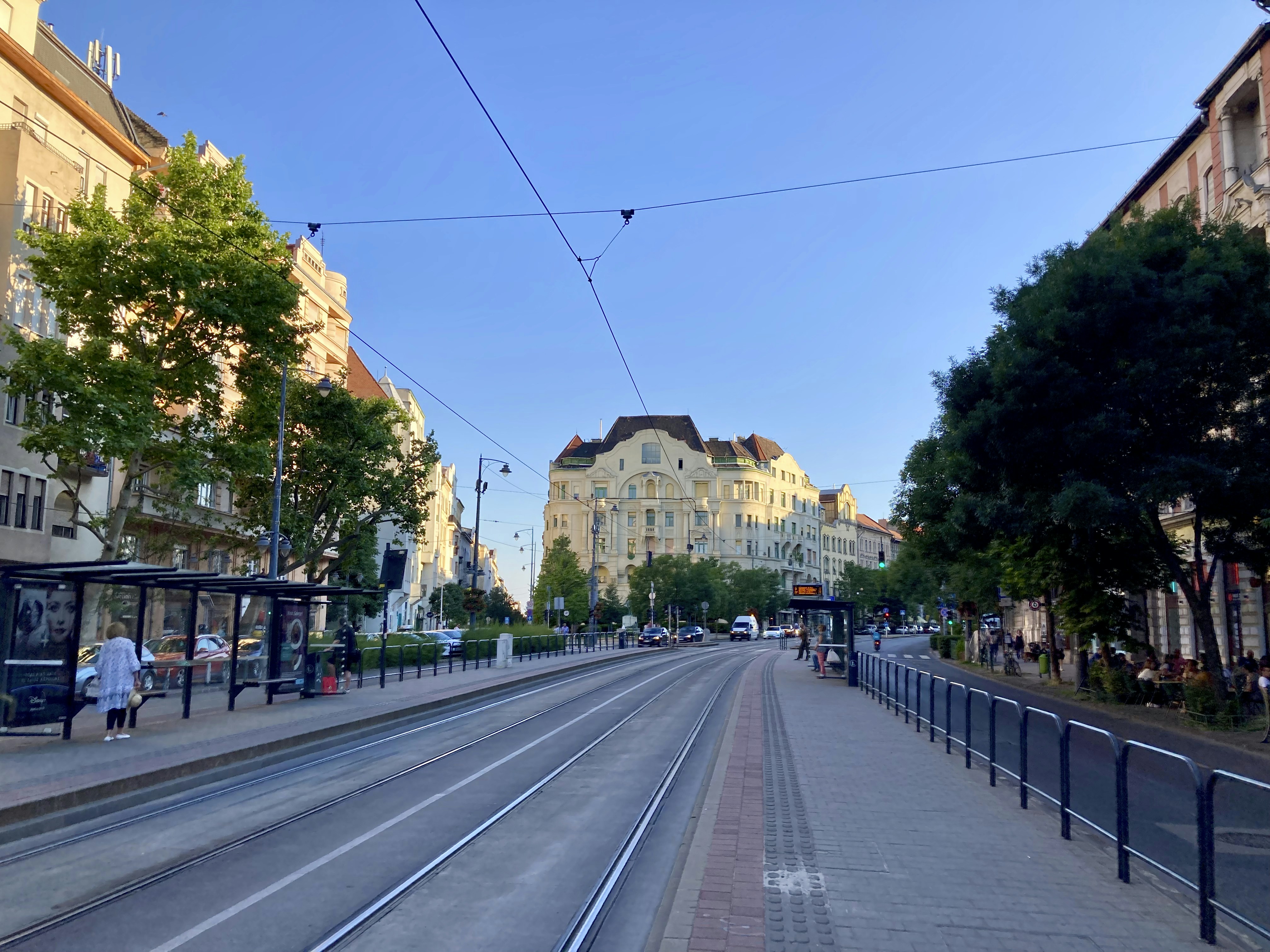 A train track running through a city street photo – Free Budapest Image ...