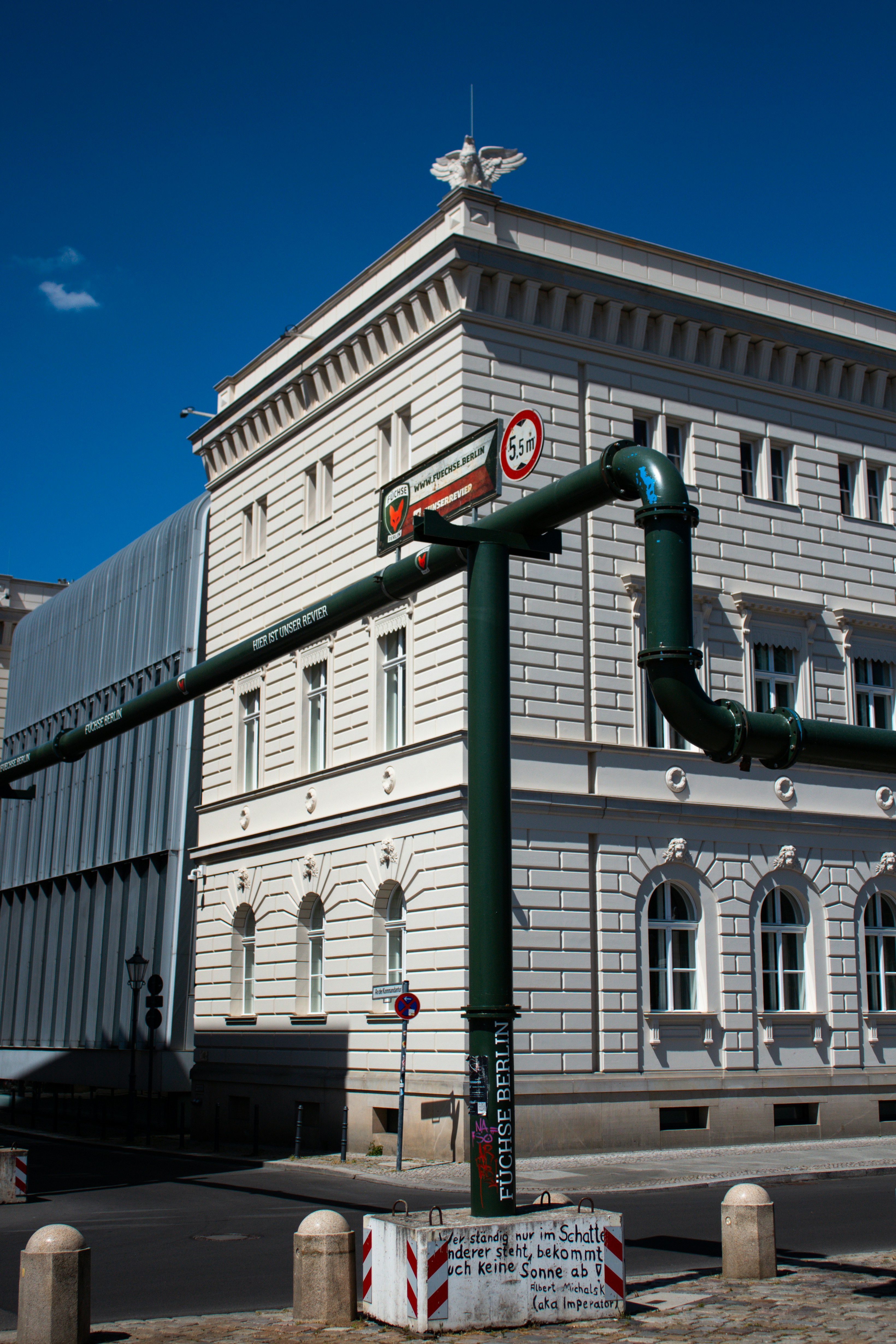 Corner of Stone and Steel: Pipeline Framing a Neoclassical Facade