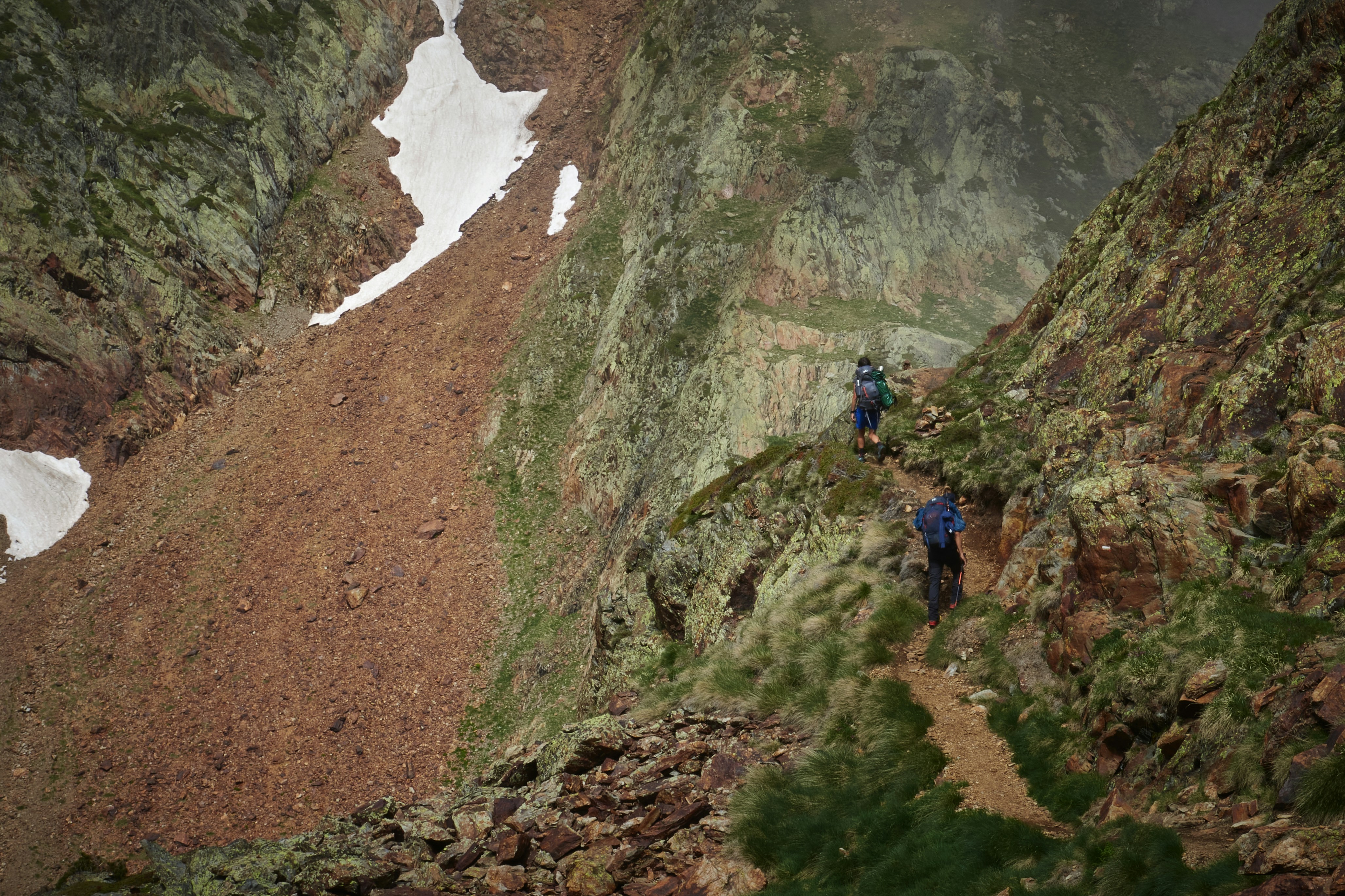 Trailbound Figures Climbing a Steep Ridge