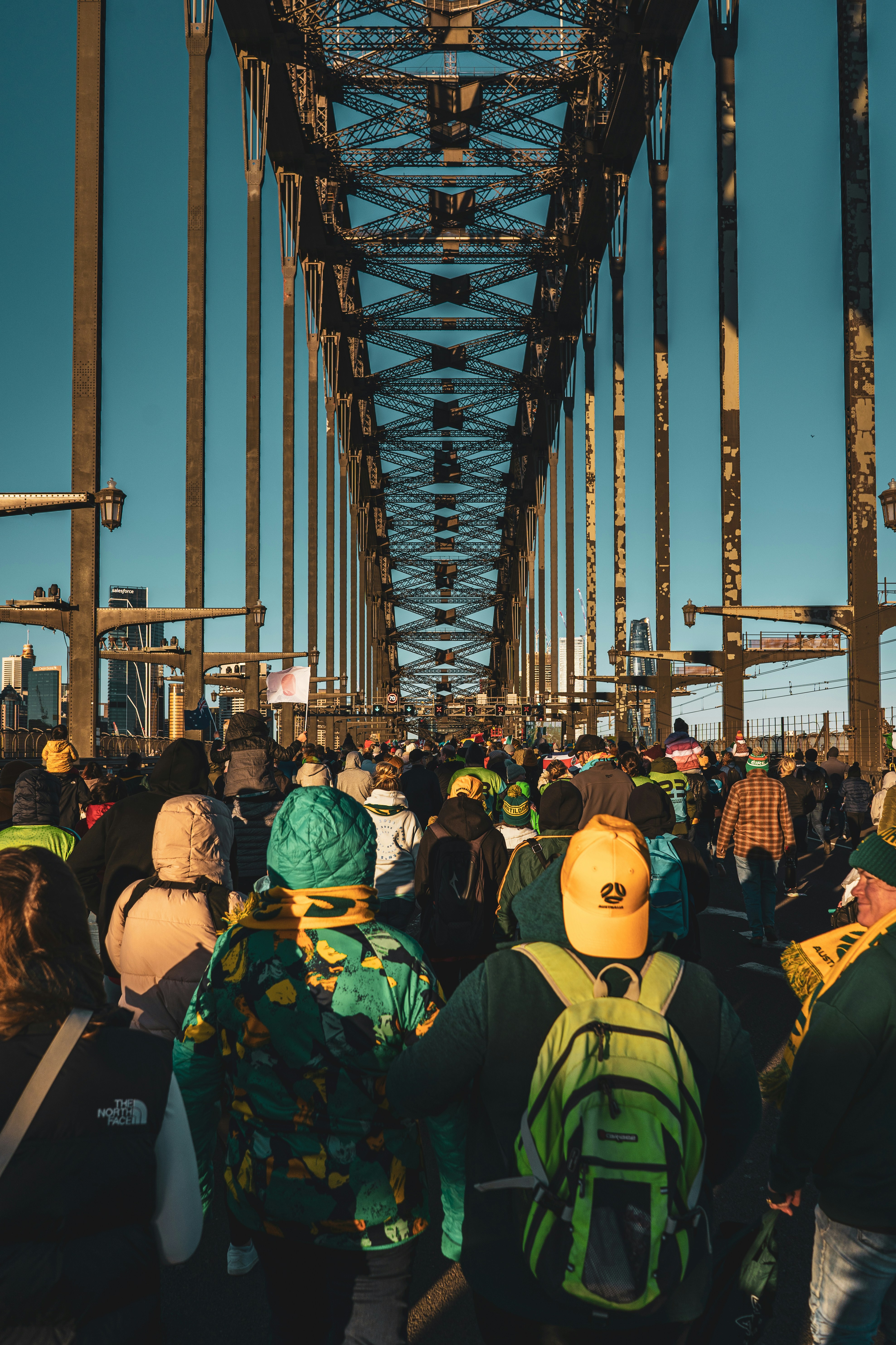 Crowd Crossing the Steel Span at Dusk