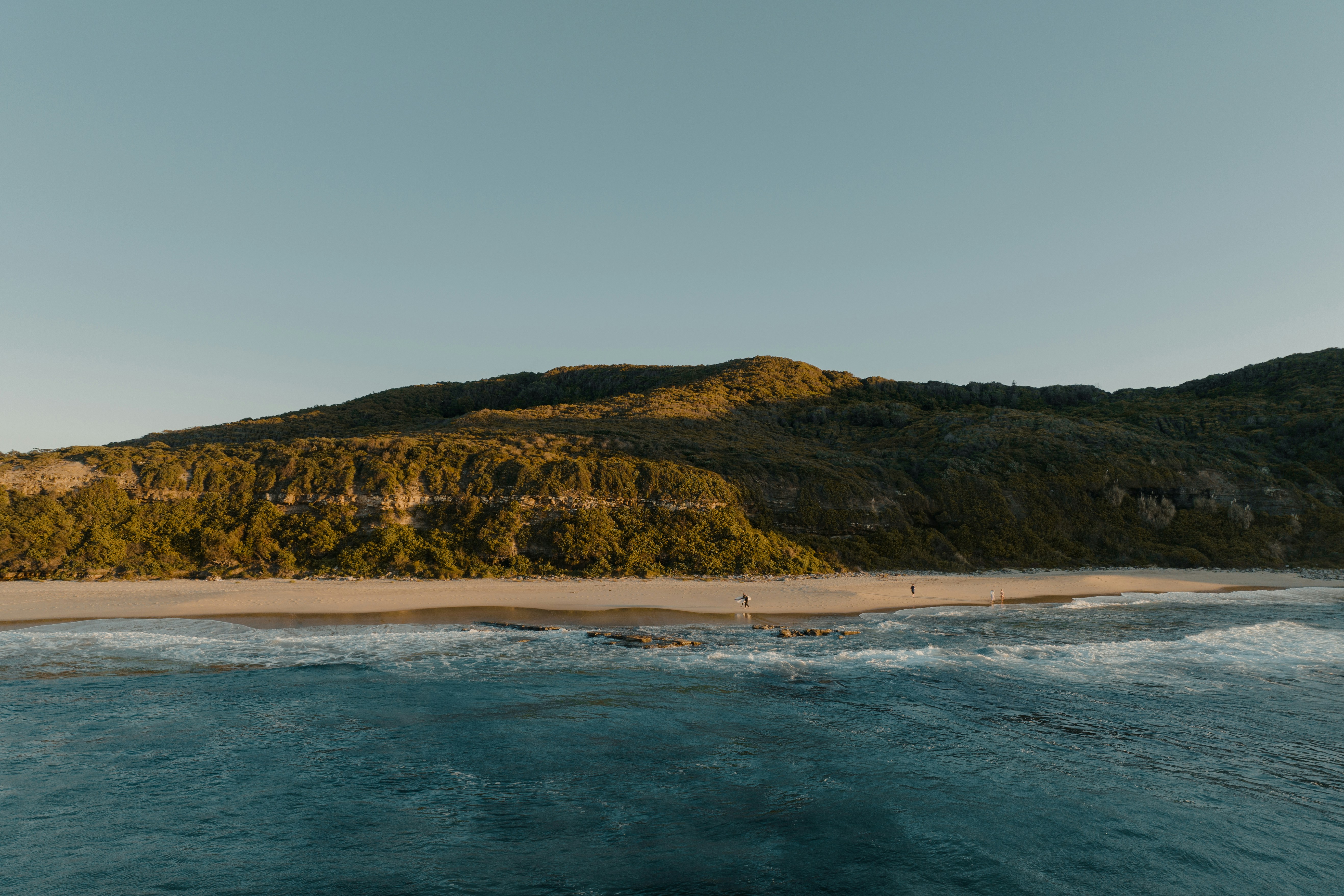 Amber Dunes Framing a Quiet Coastline from Above