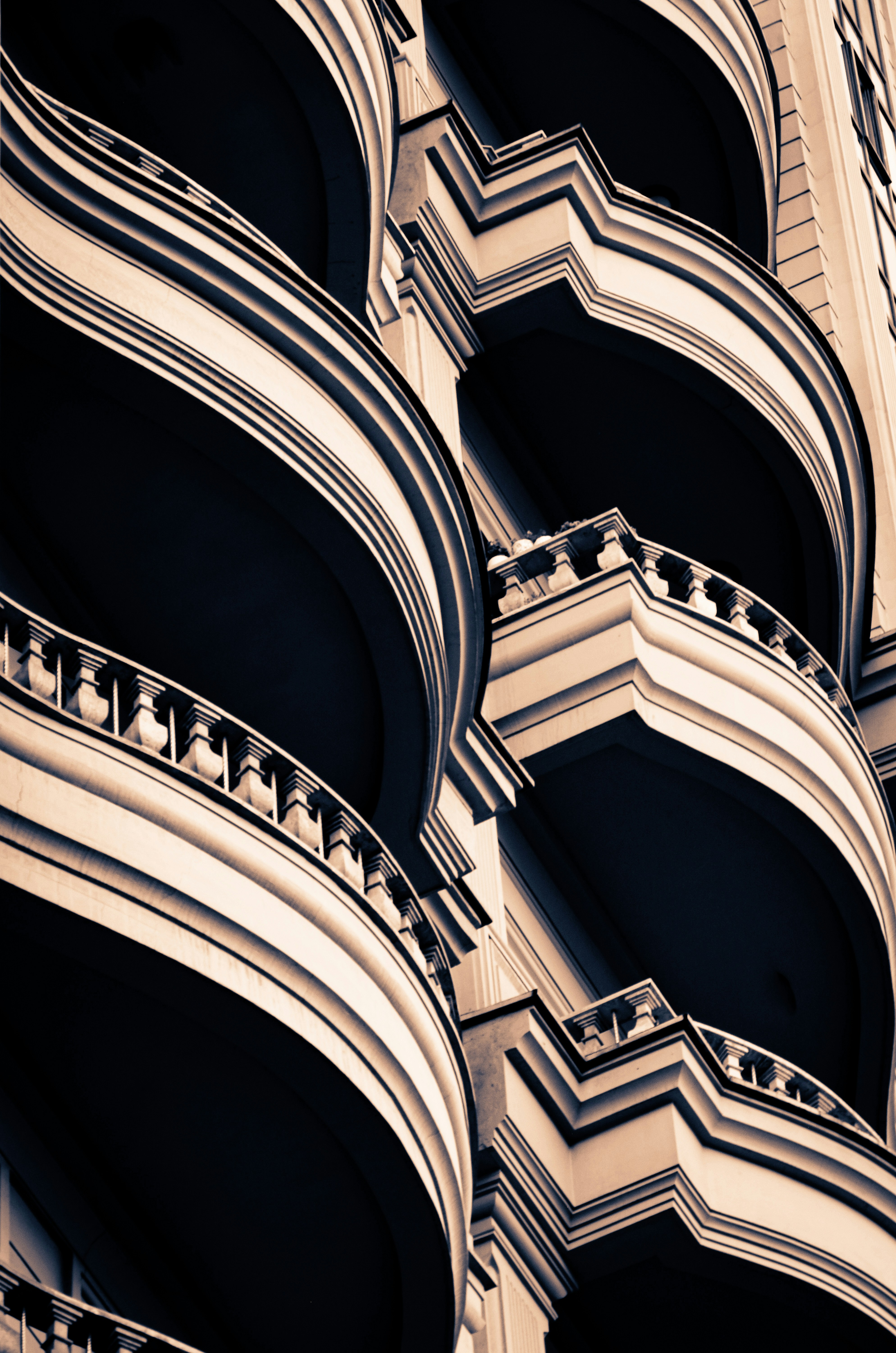 Curved Facades in Shadow: An Abstract Ballet of Balconies