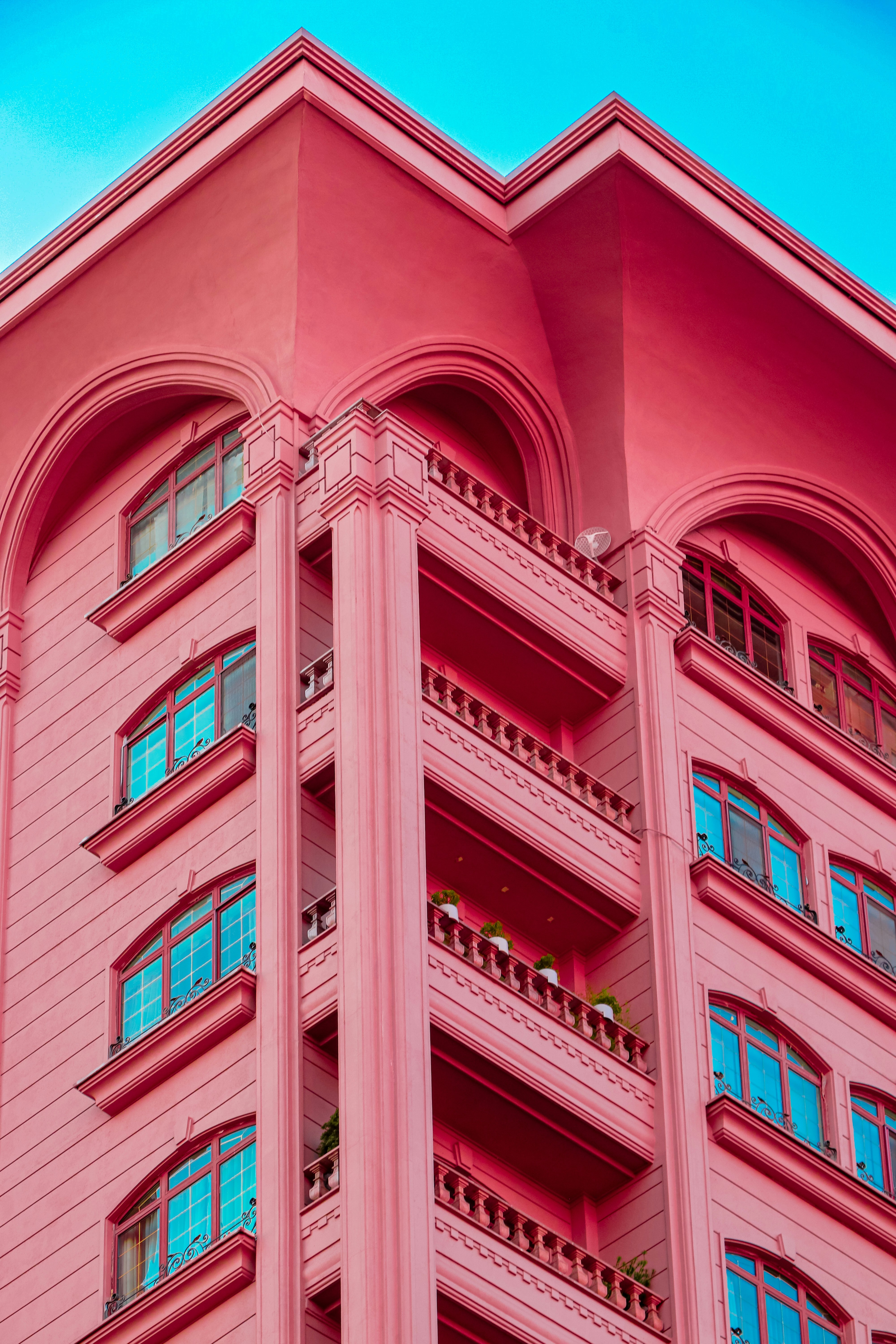 Crimson Veranda Alignment: Arched Facade with Tiered Balconies