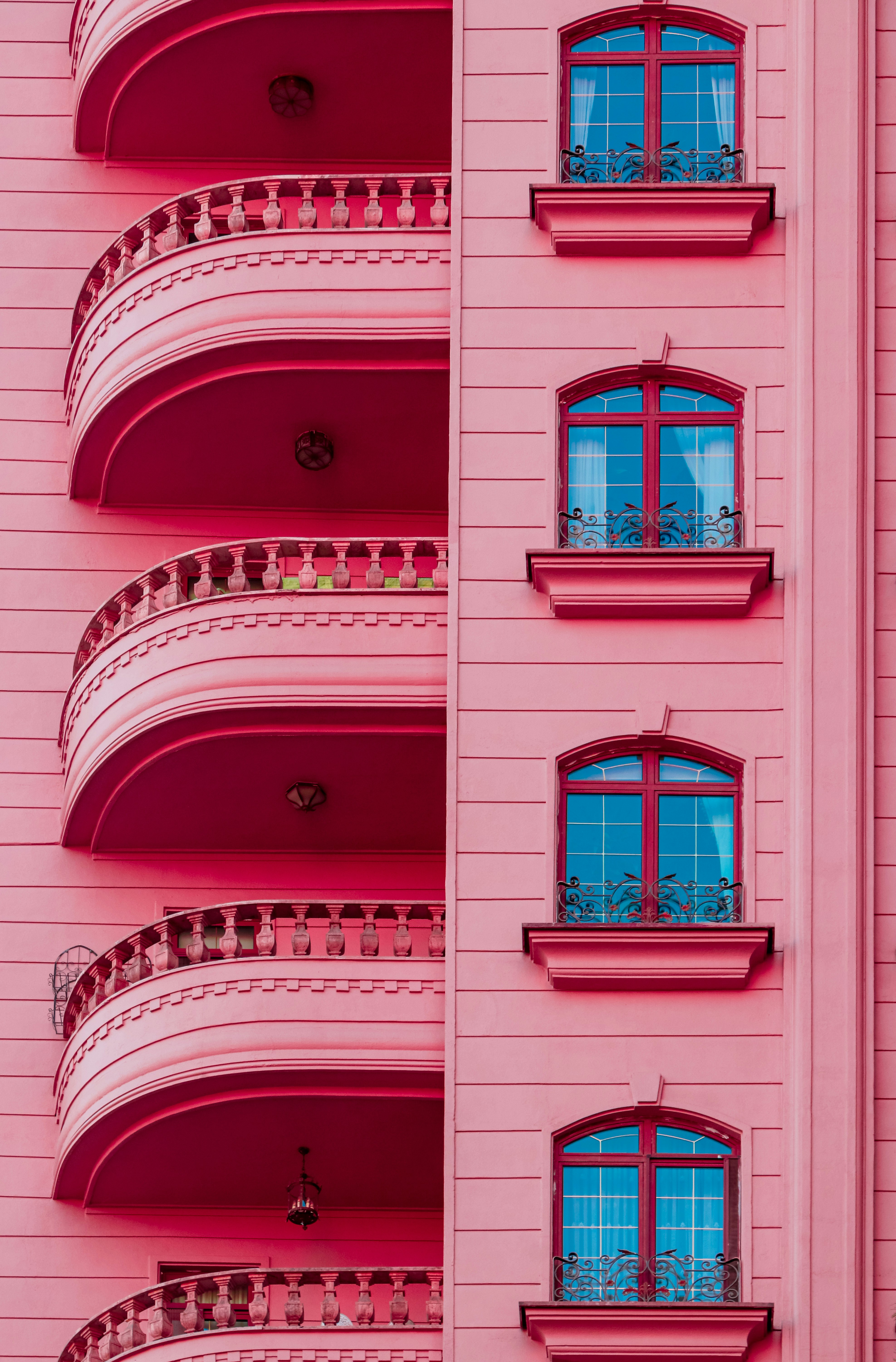 A tall pink building with balconies and balconies photo – Free Tehran ...