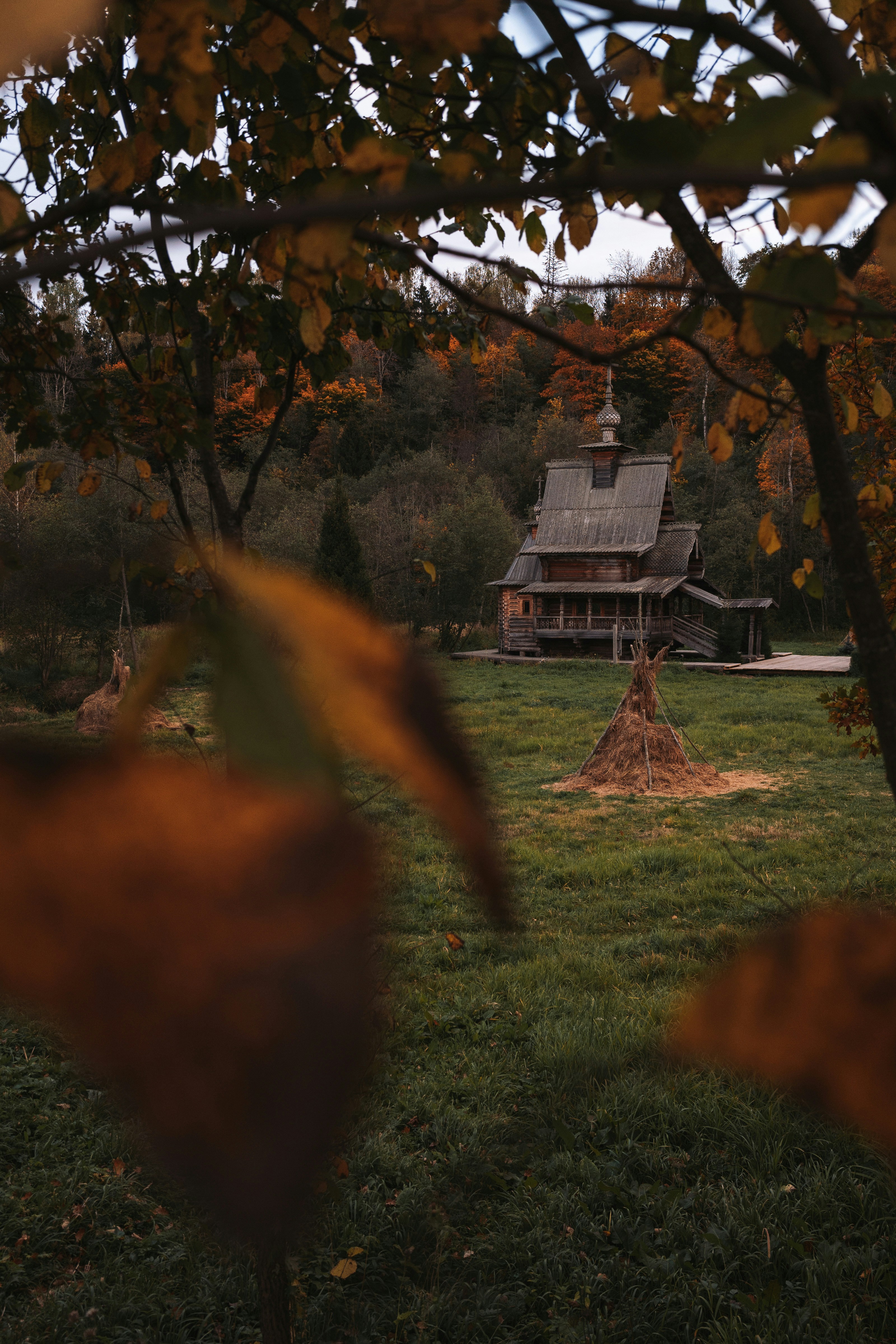 A house in the distance with trees in the foreground photo – Free ...