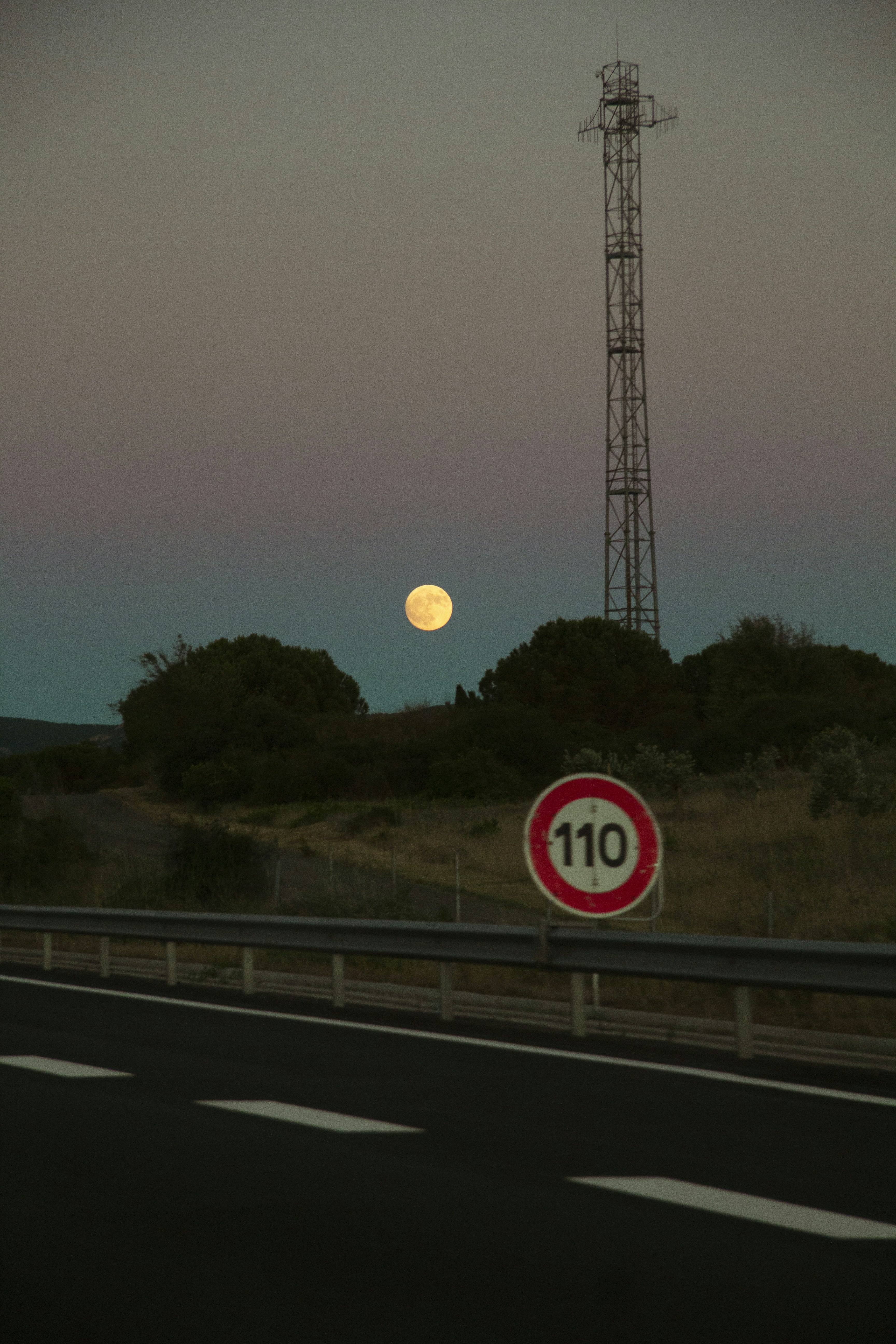 Moonrise by the Tower: Dusk on a Quiet Highway