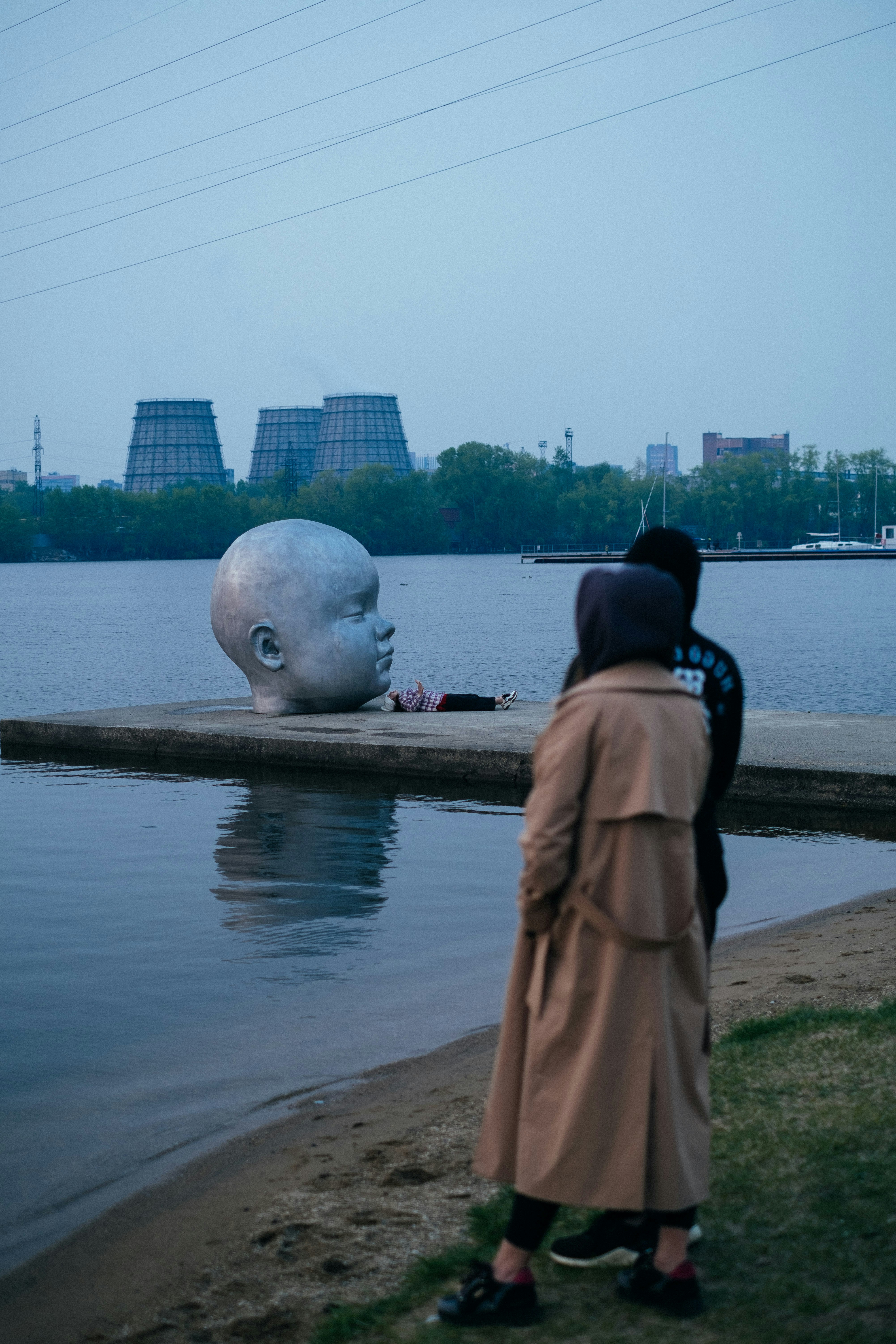 To Regardless We Move: A Sculpted Head by the Water