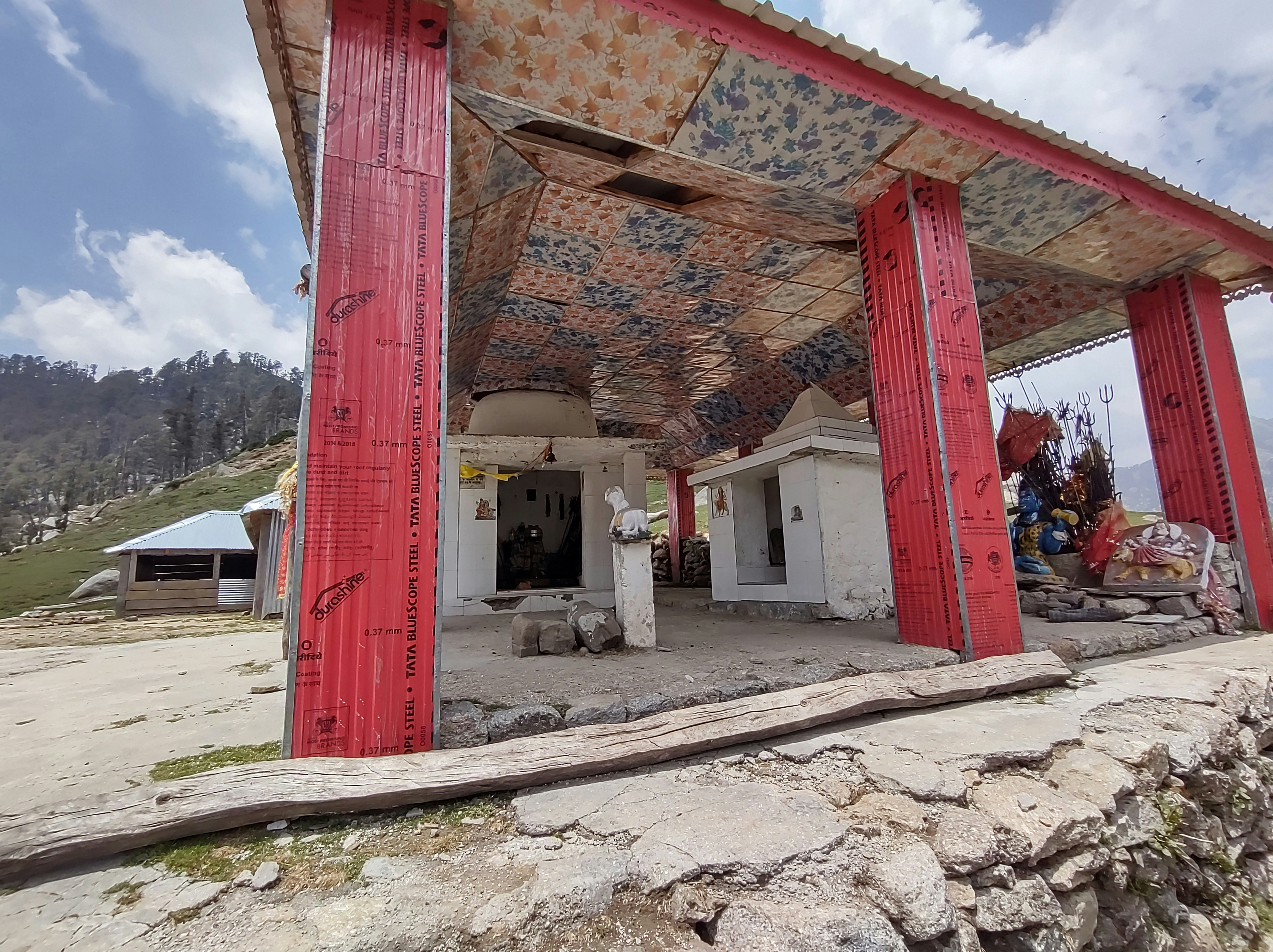 a red structure with people sitting on it