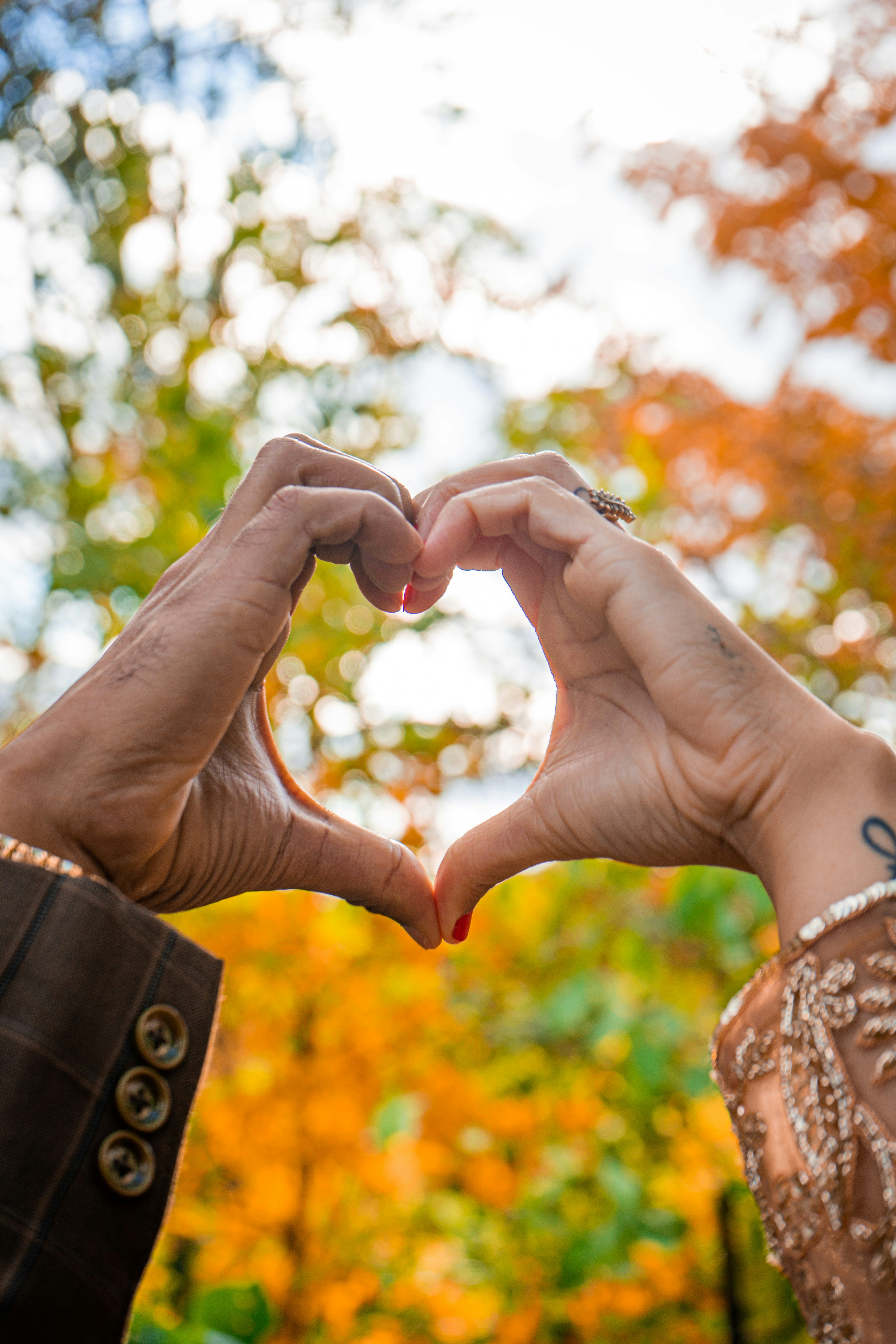 Two People Making A Heart With Their Hands