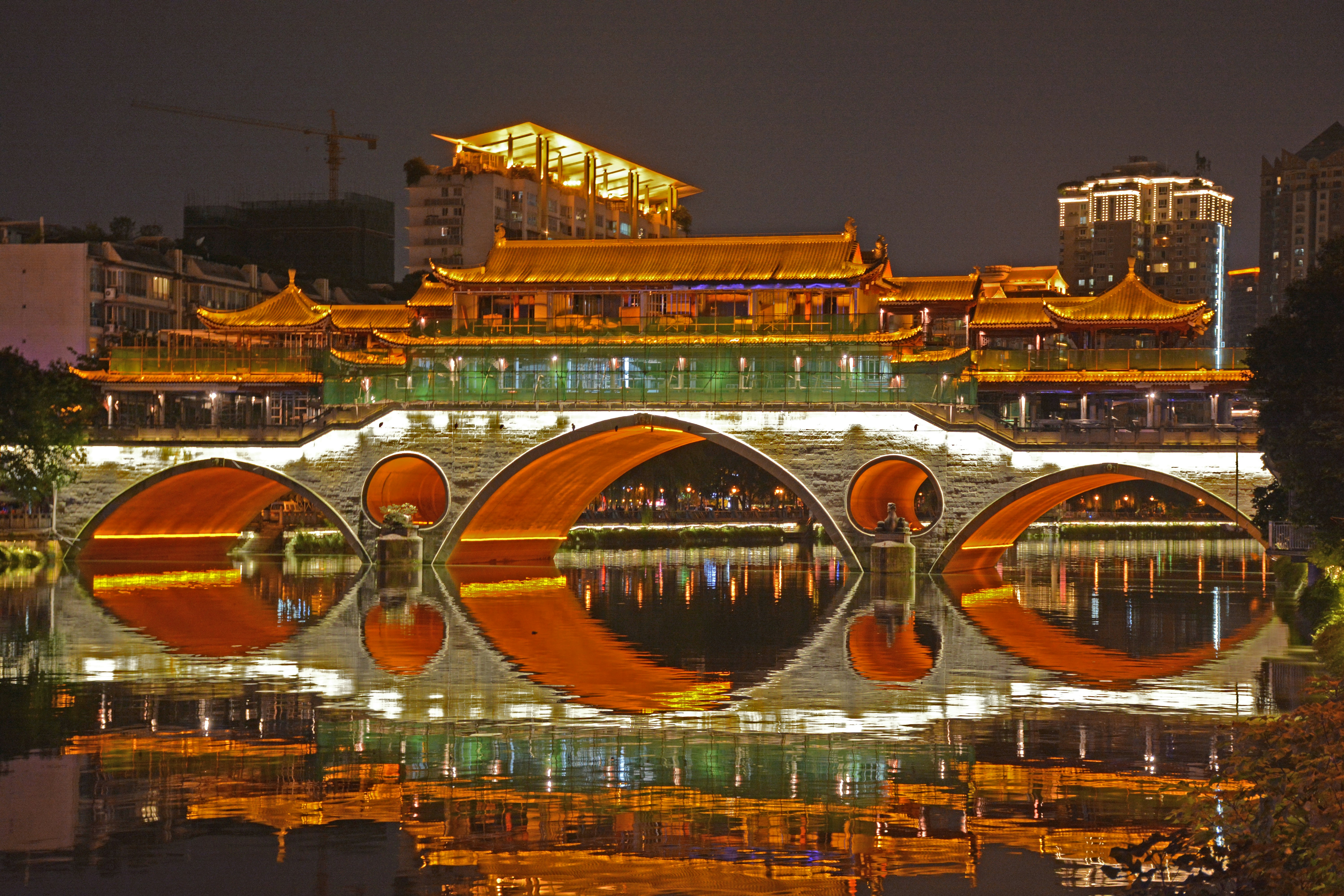 Midnight Arches: Golden Reflections of a City Bridge