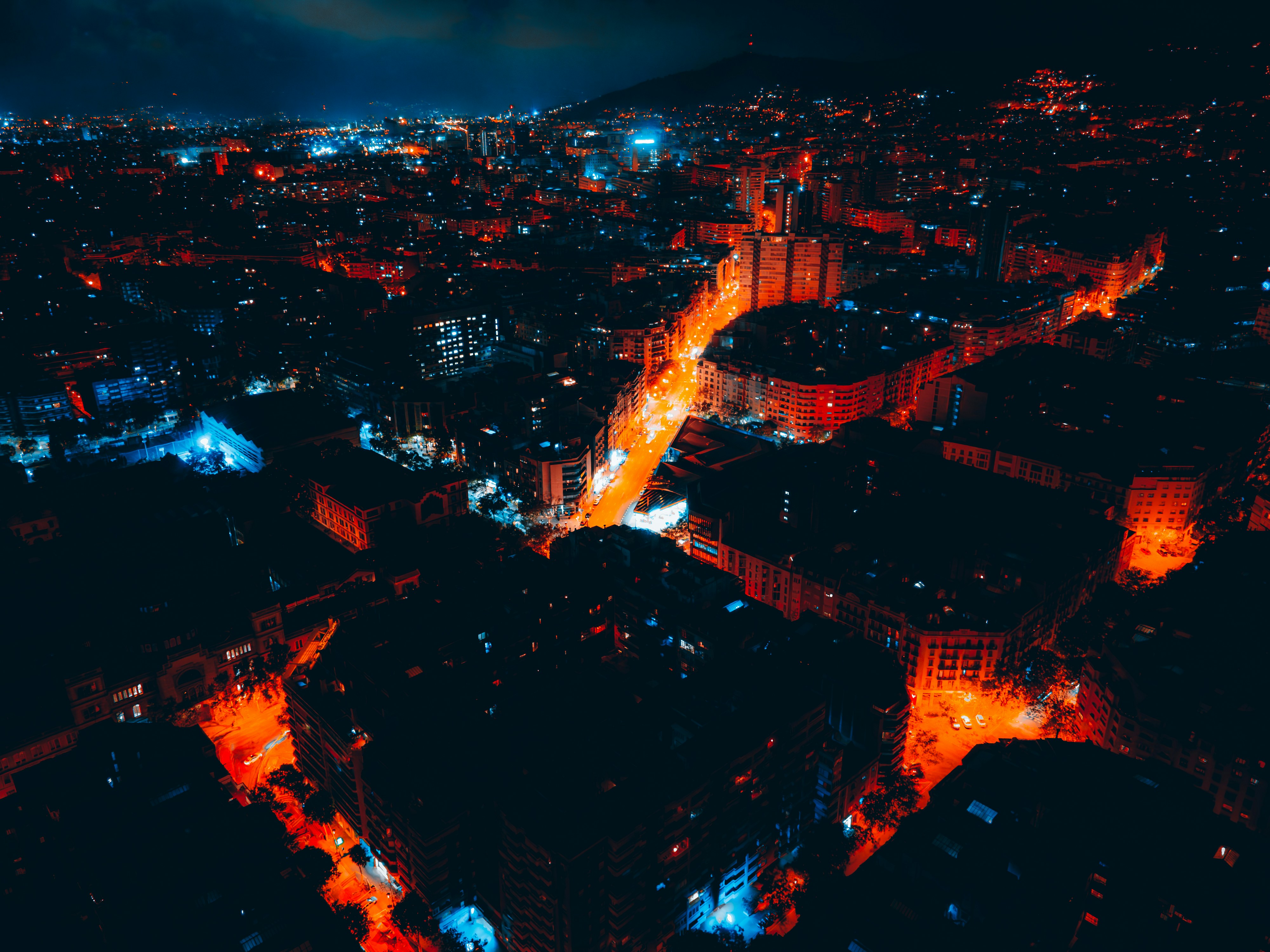 Crimson Corridors over a Blue-Hued Metropolis at Night