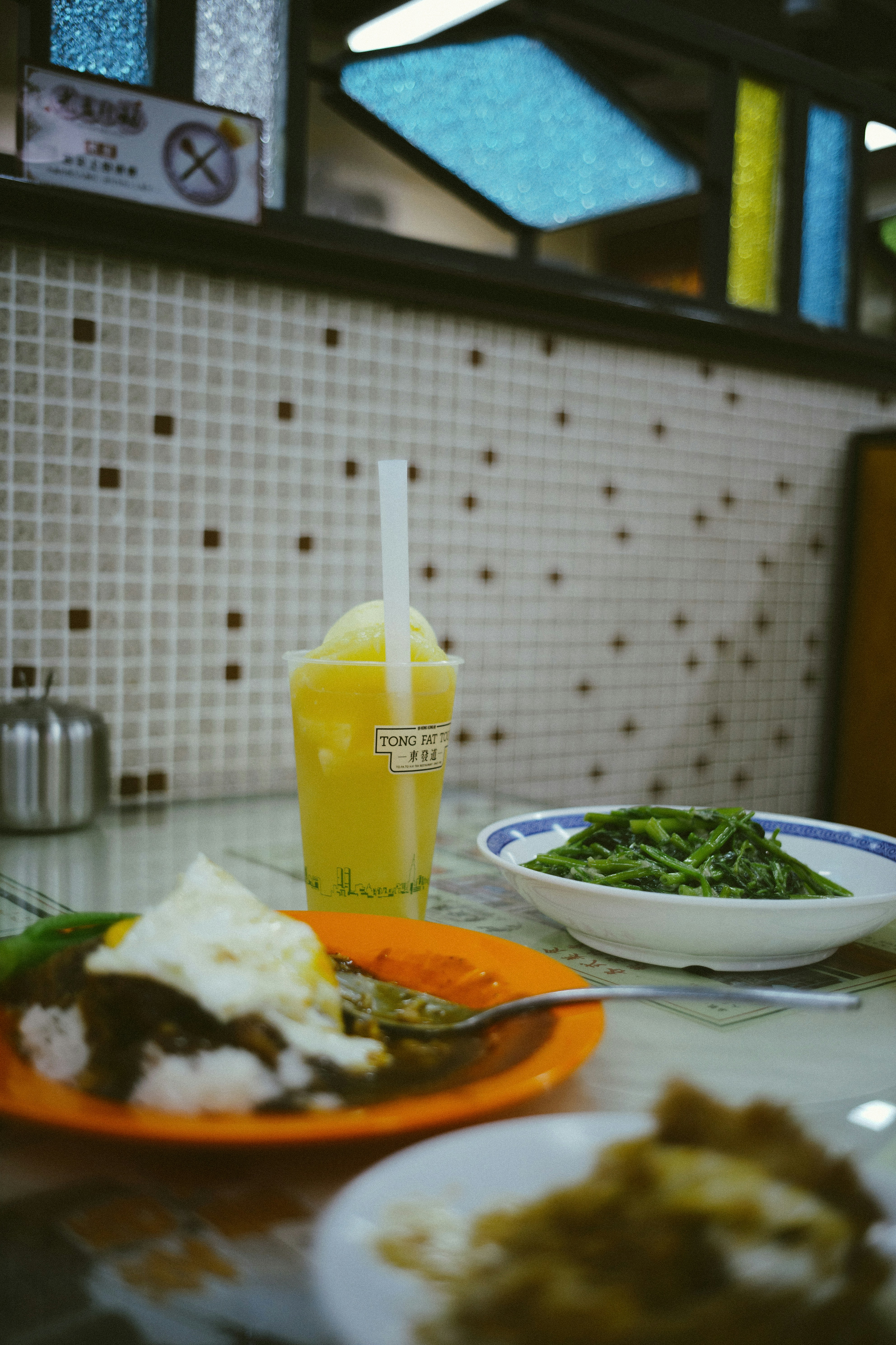 a table topped with plates of food and a drink