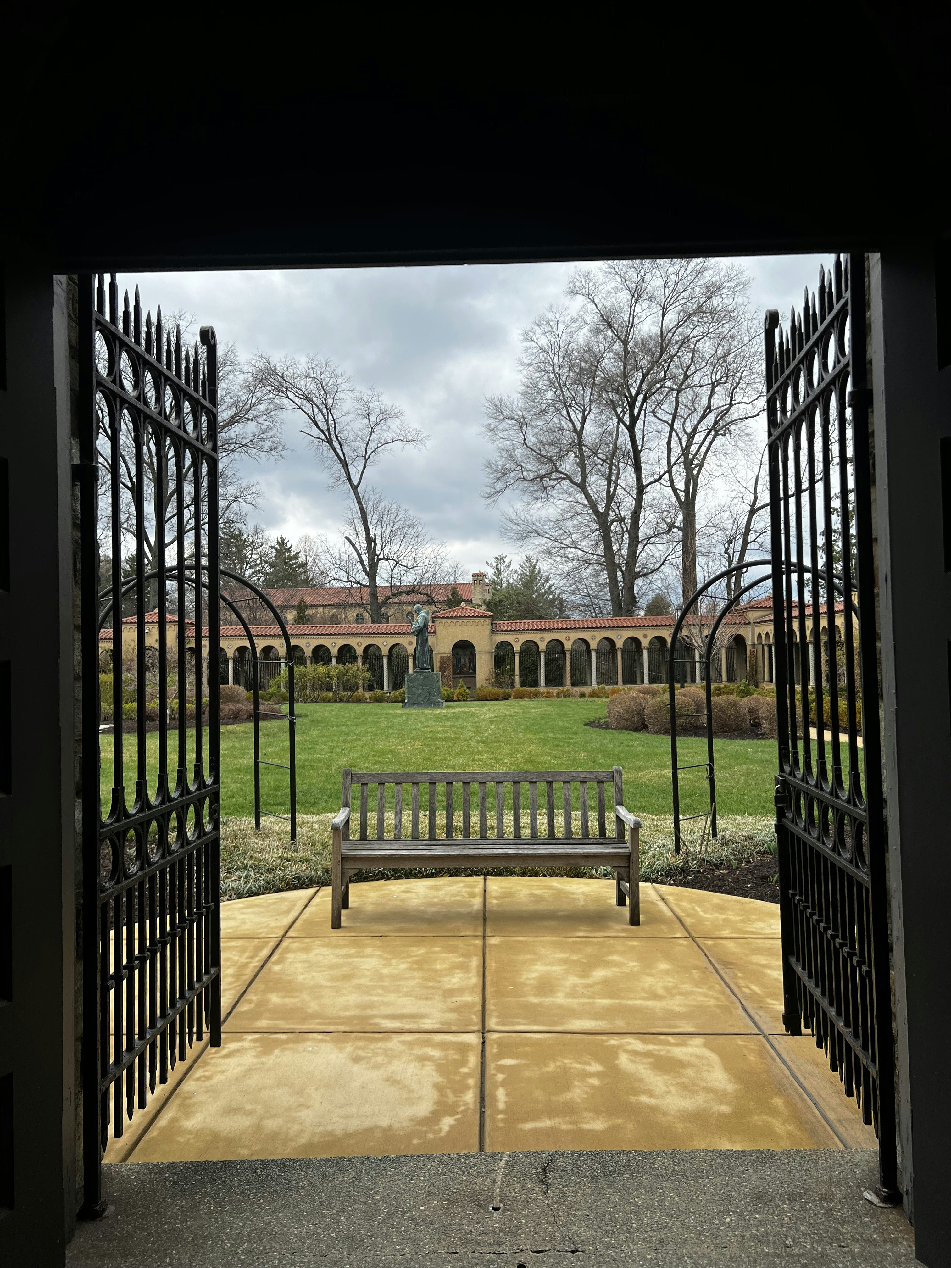 An open gate with a bench in the middle of it photo – Free Gothic Image ...