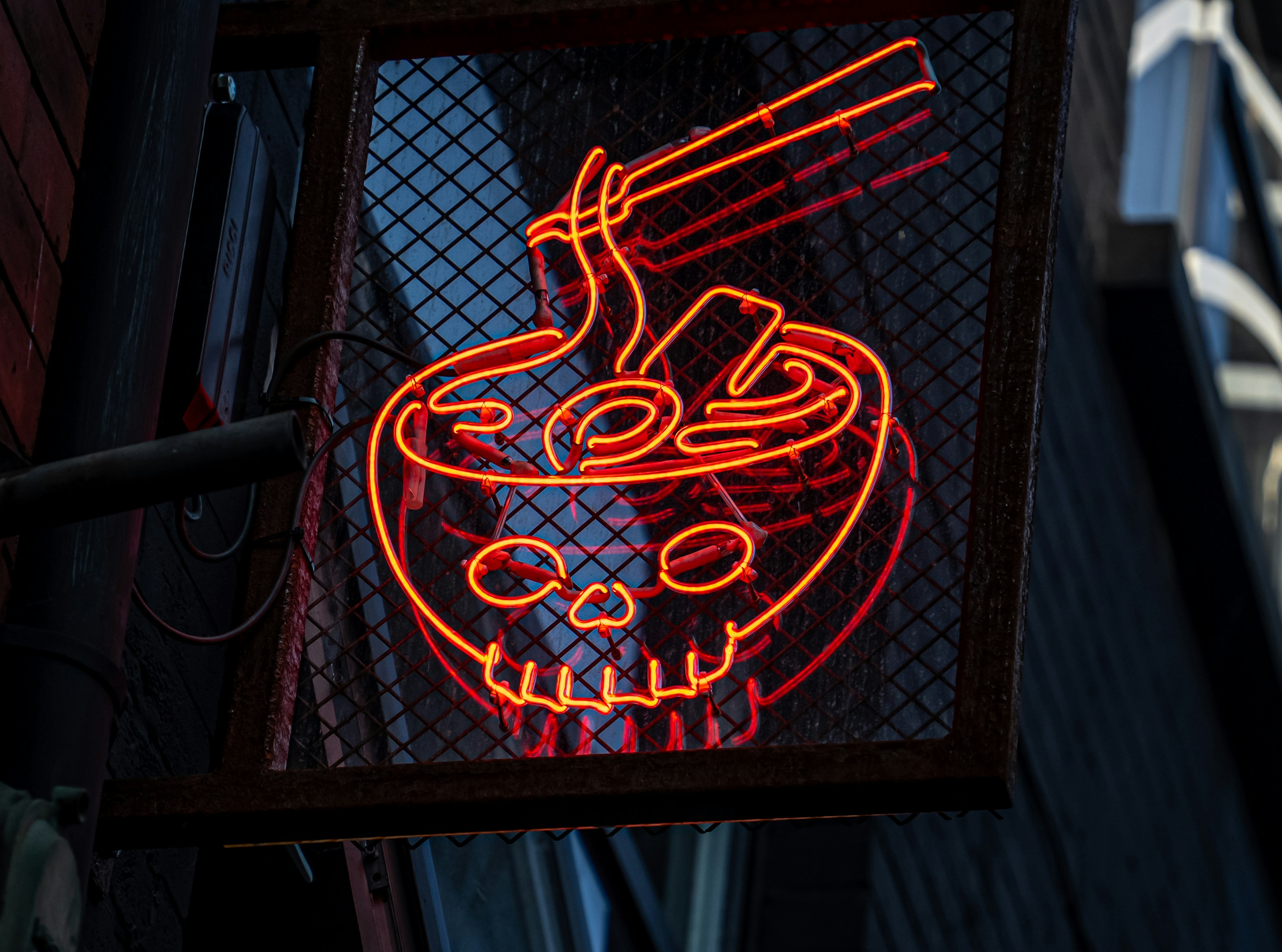 A neon sign on the side of a building photo – Free Belfast Image on ...