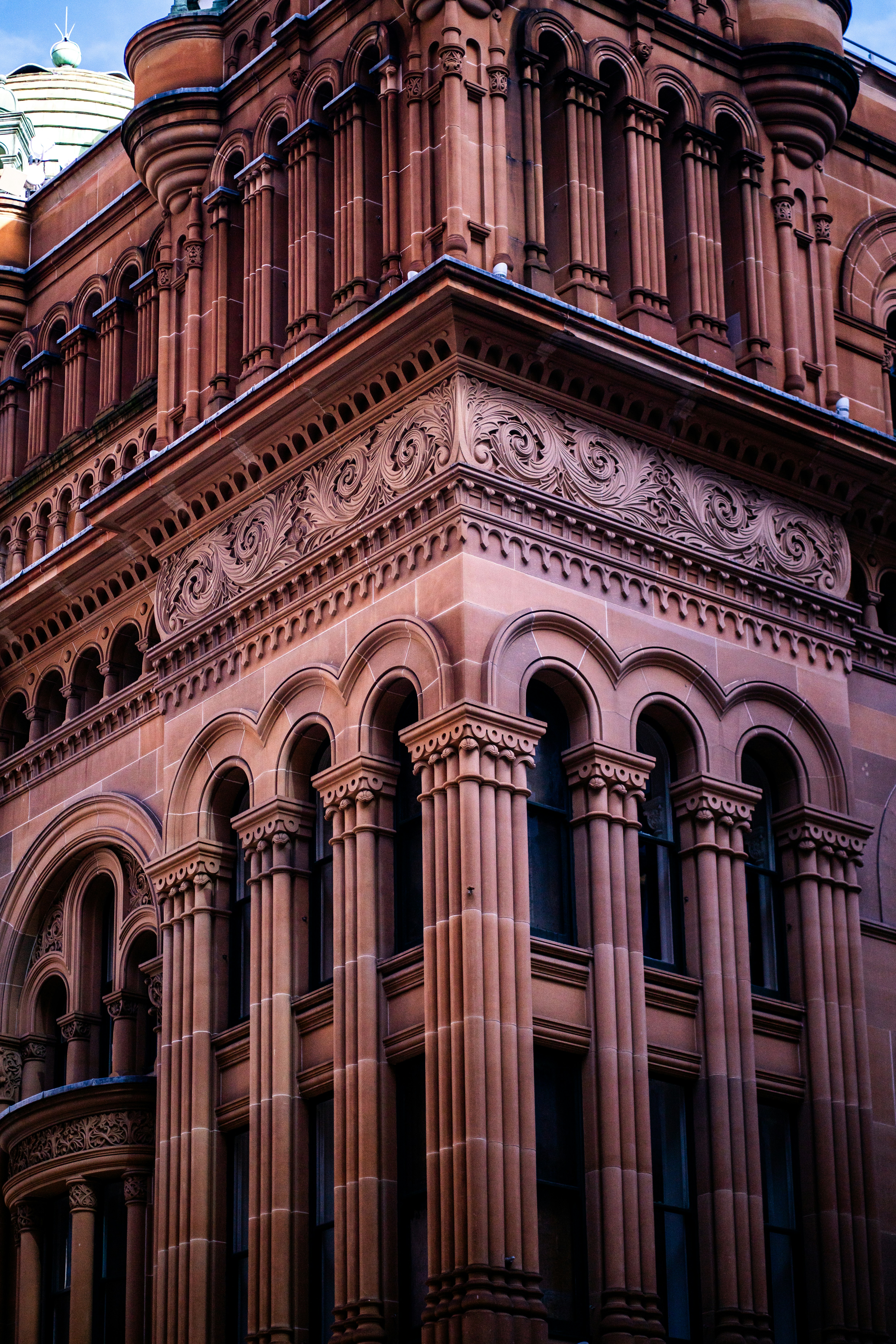 Rust-Red Arches: Close-Up of Ornate Brickwork on a Romanesque Facade