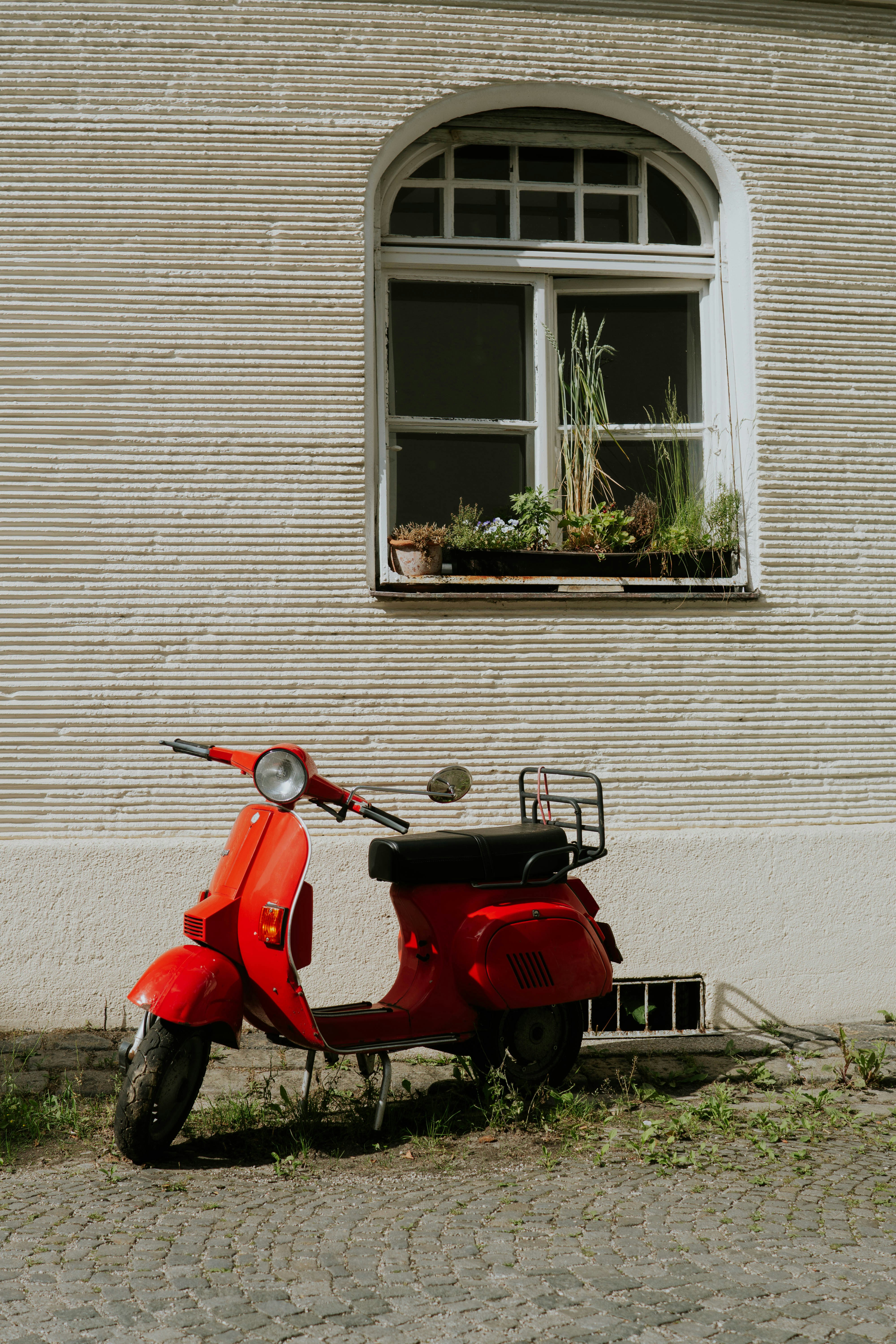 Red Vespa by a Quiet Window