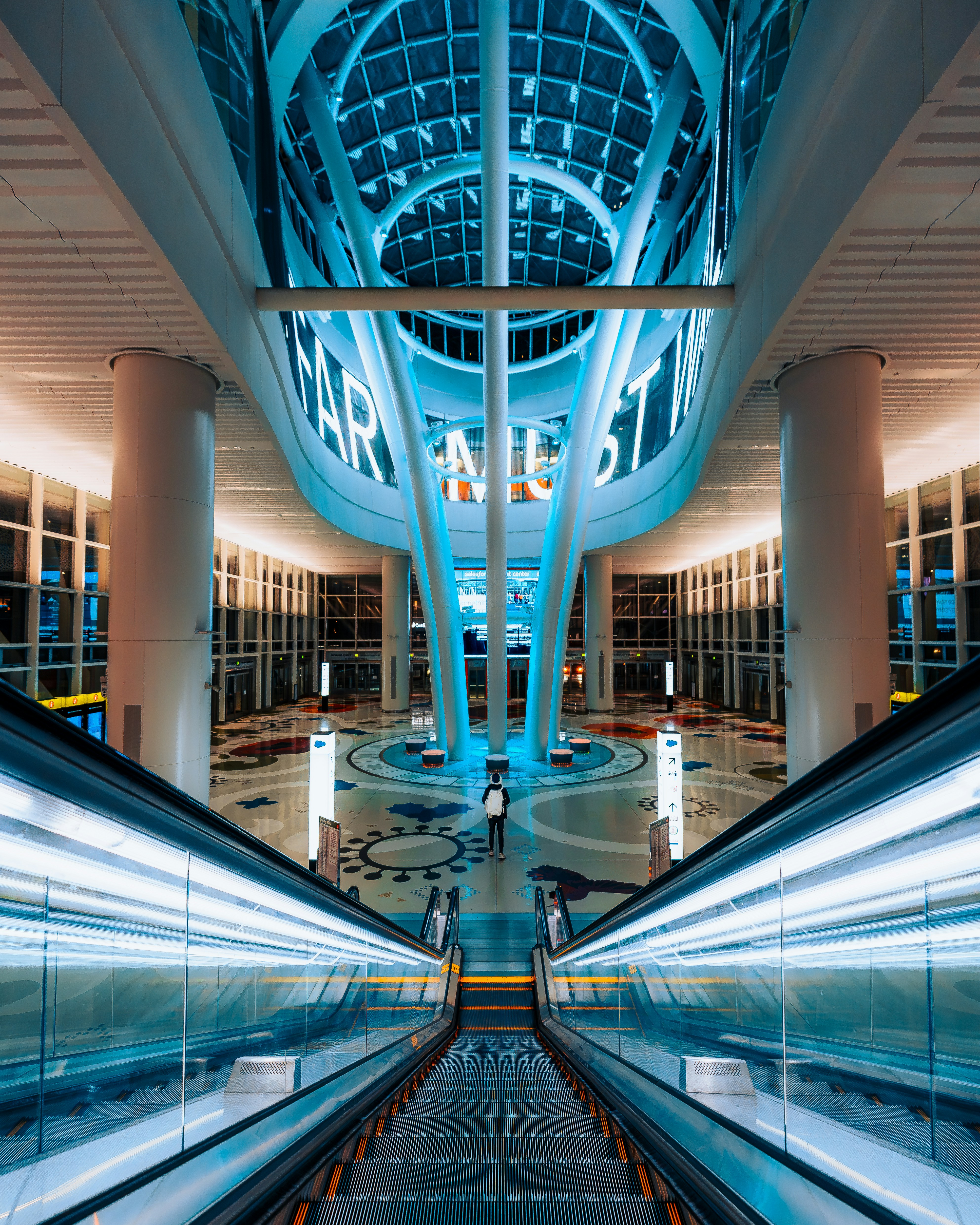 An escalator in a large building with a clock on the wall photo – Free ...