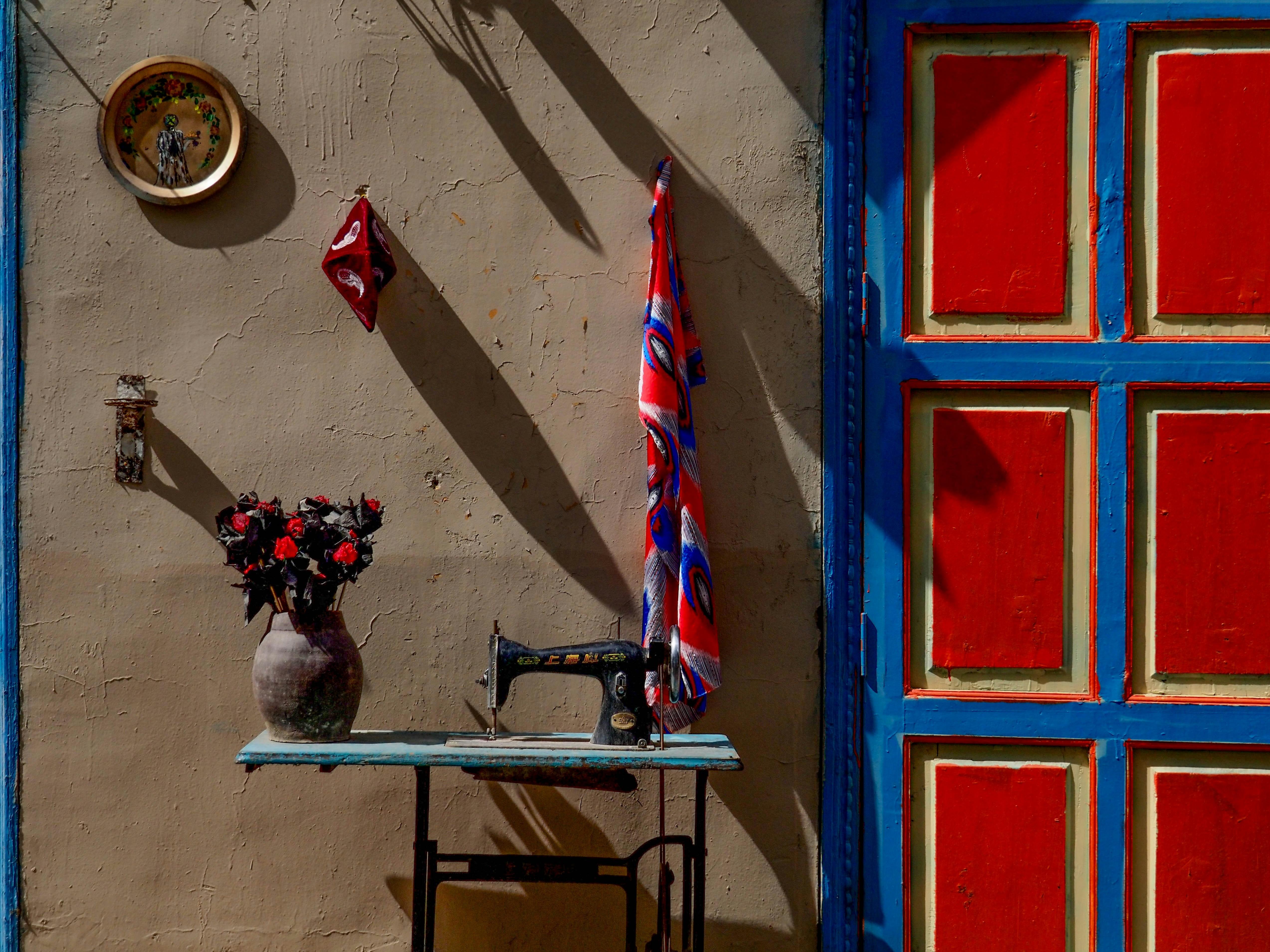 Threads in the Sun: A Sewing Table Graced by a Union Jack and a Bold Door