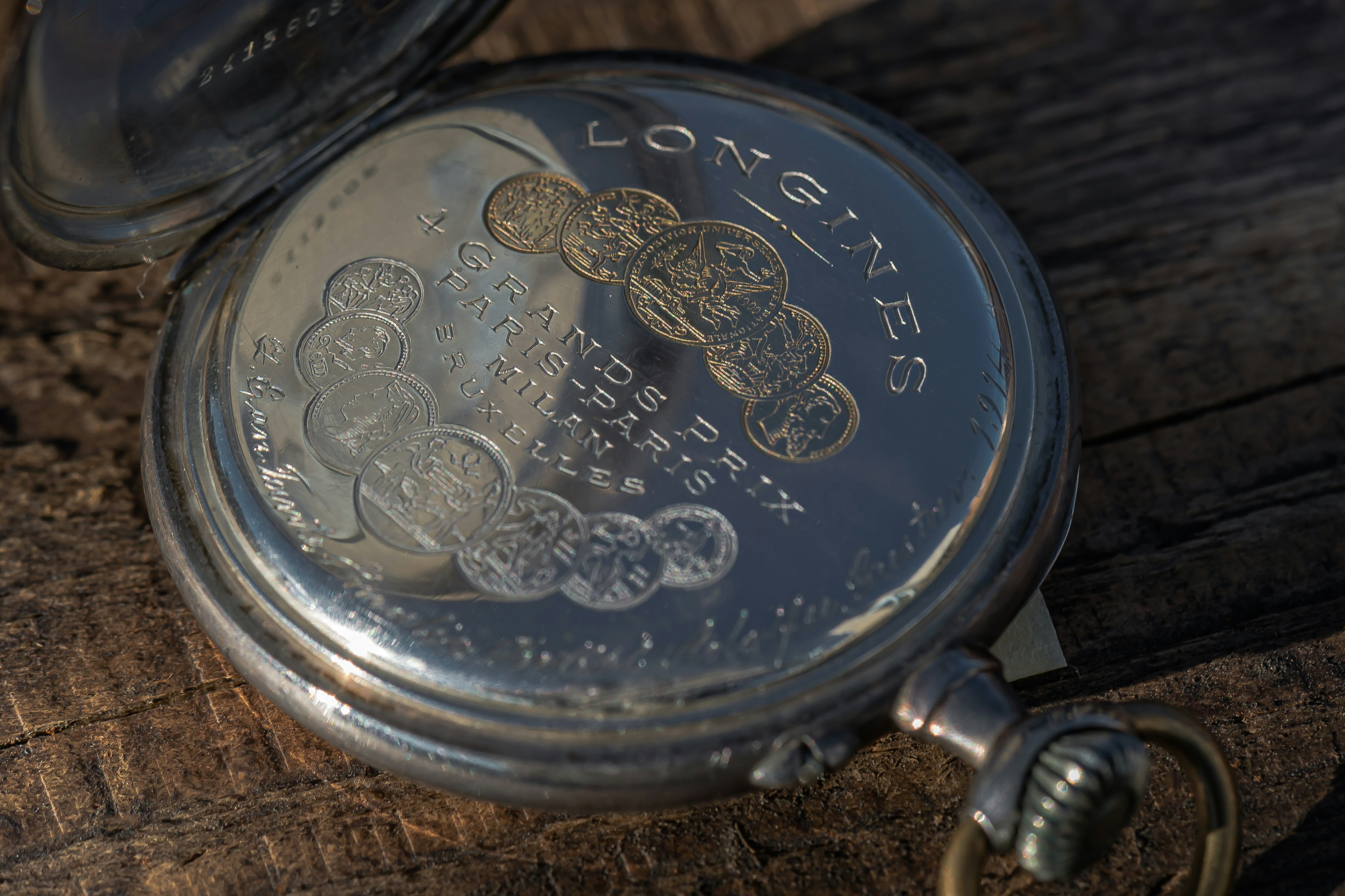A silver pocket watch sitting on top of a wooden table photo – Free ...