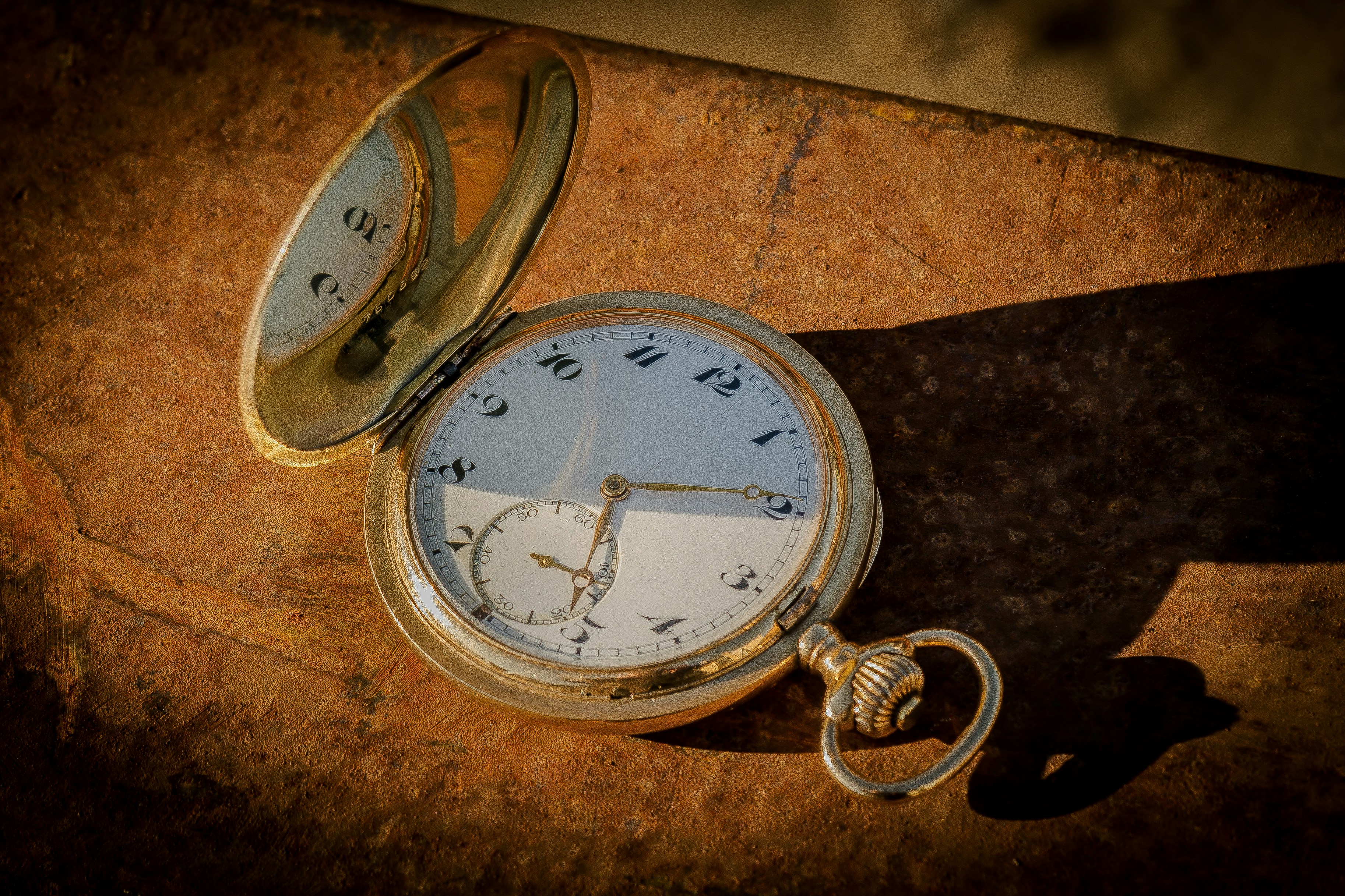 An old pocket watch laying on a rock photo – Free Countdown Image on ...