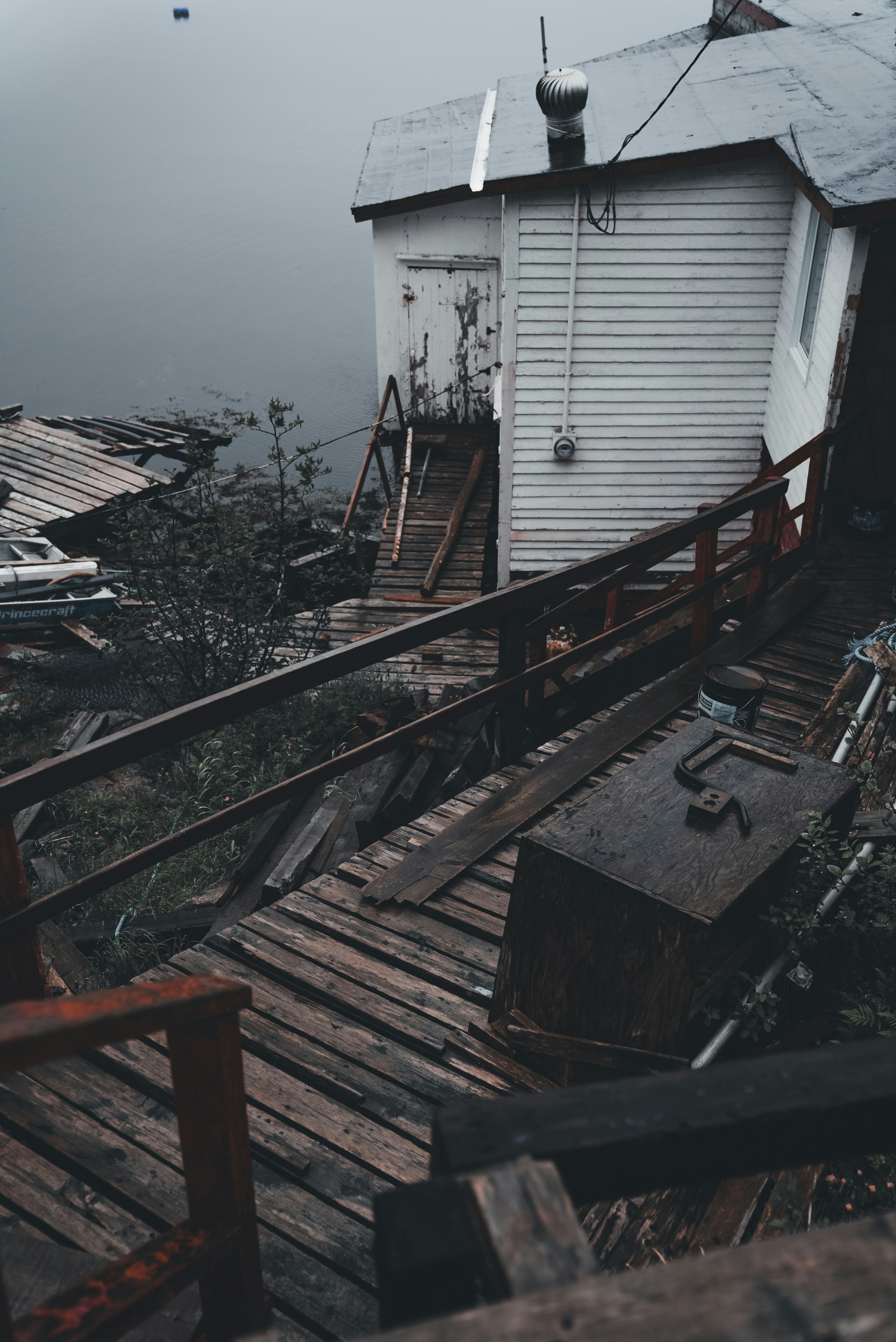 Wharfside Quiet: A Weathered Shack Clinging to a Wooden Dock