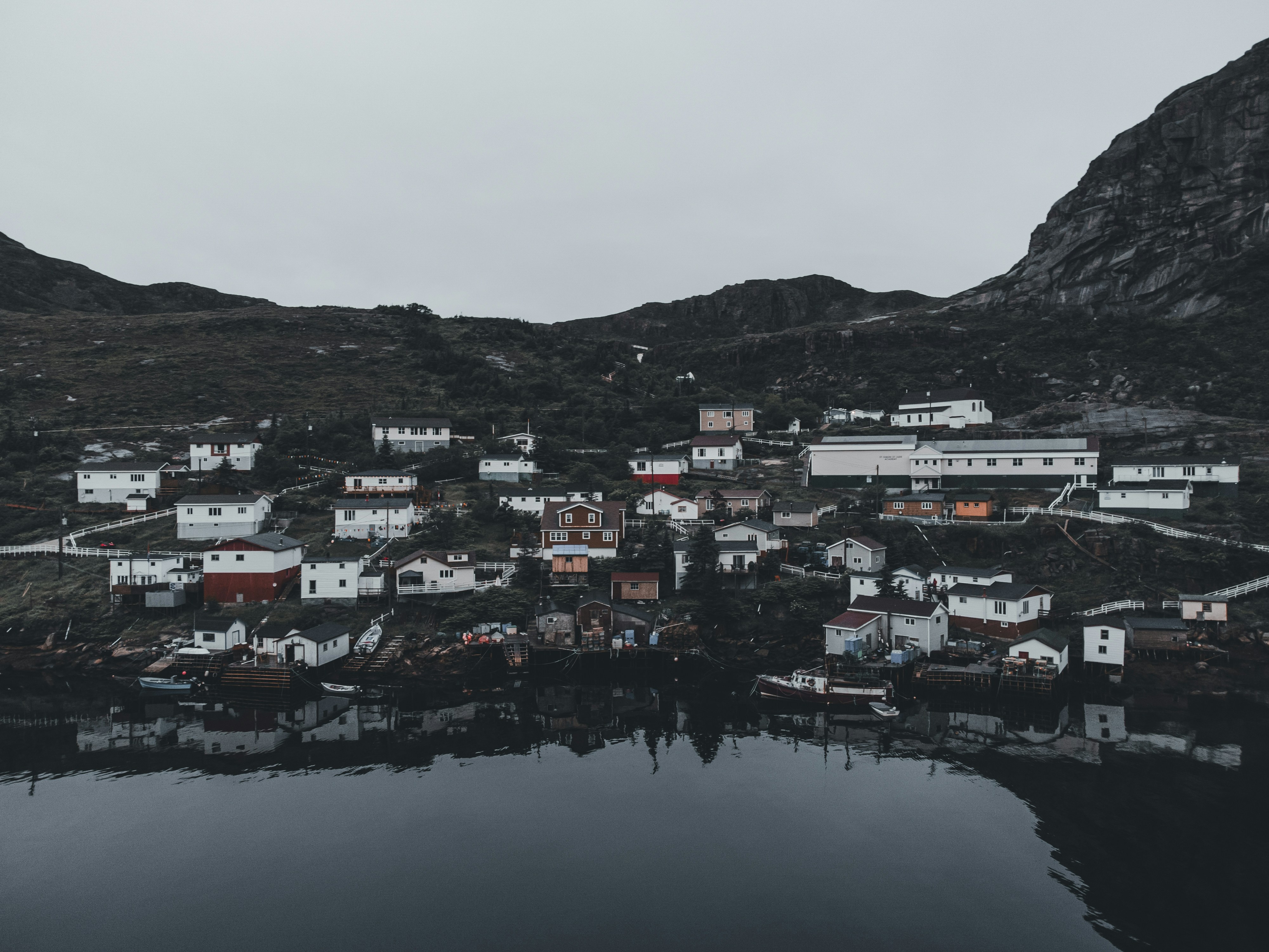 A small town on a hill next to a body of water photo – Free Building ...