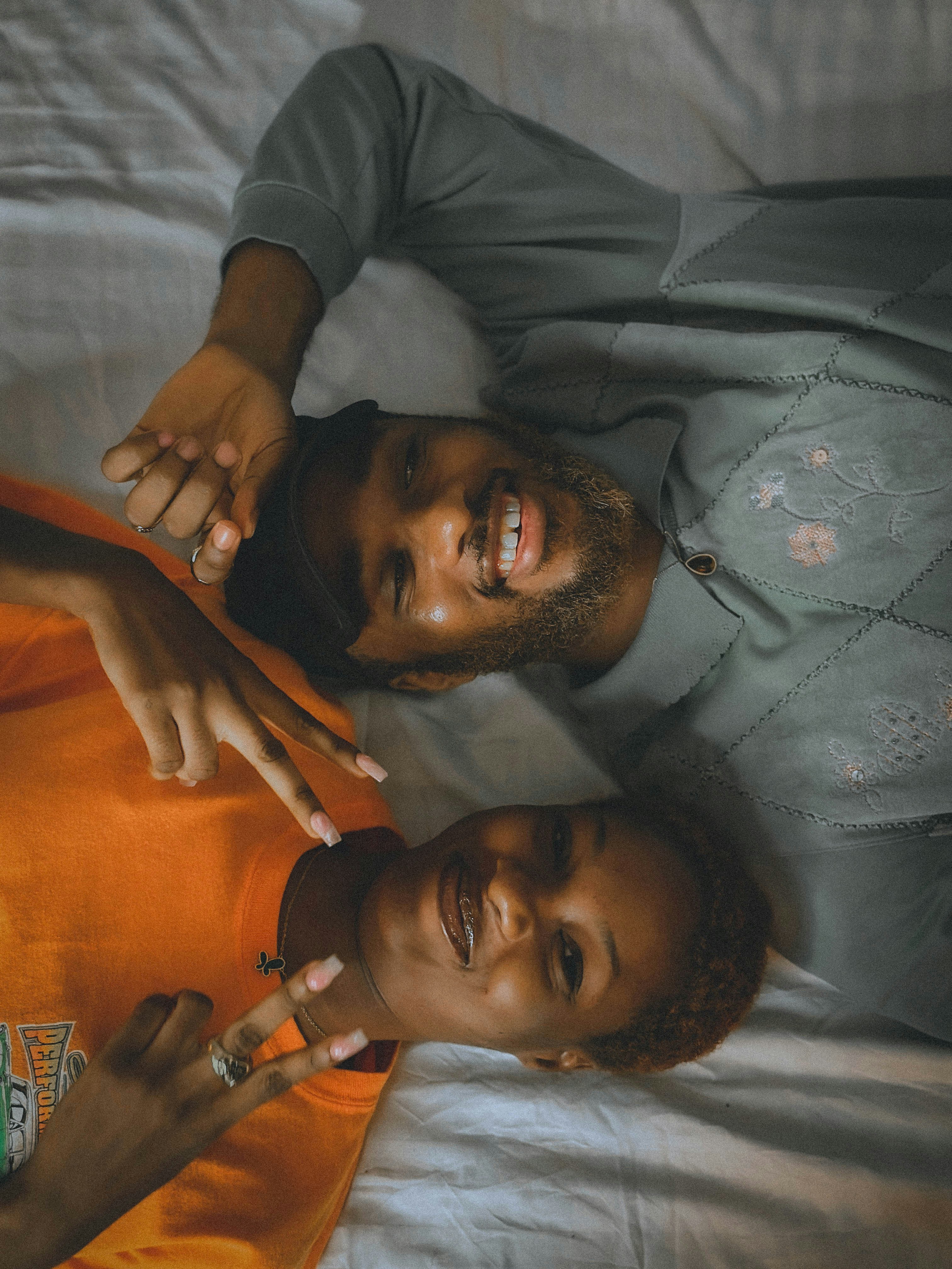 Close-Quarters Joy: A Duo's Warm Smile on a Bed