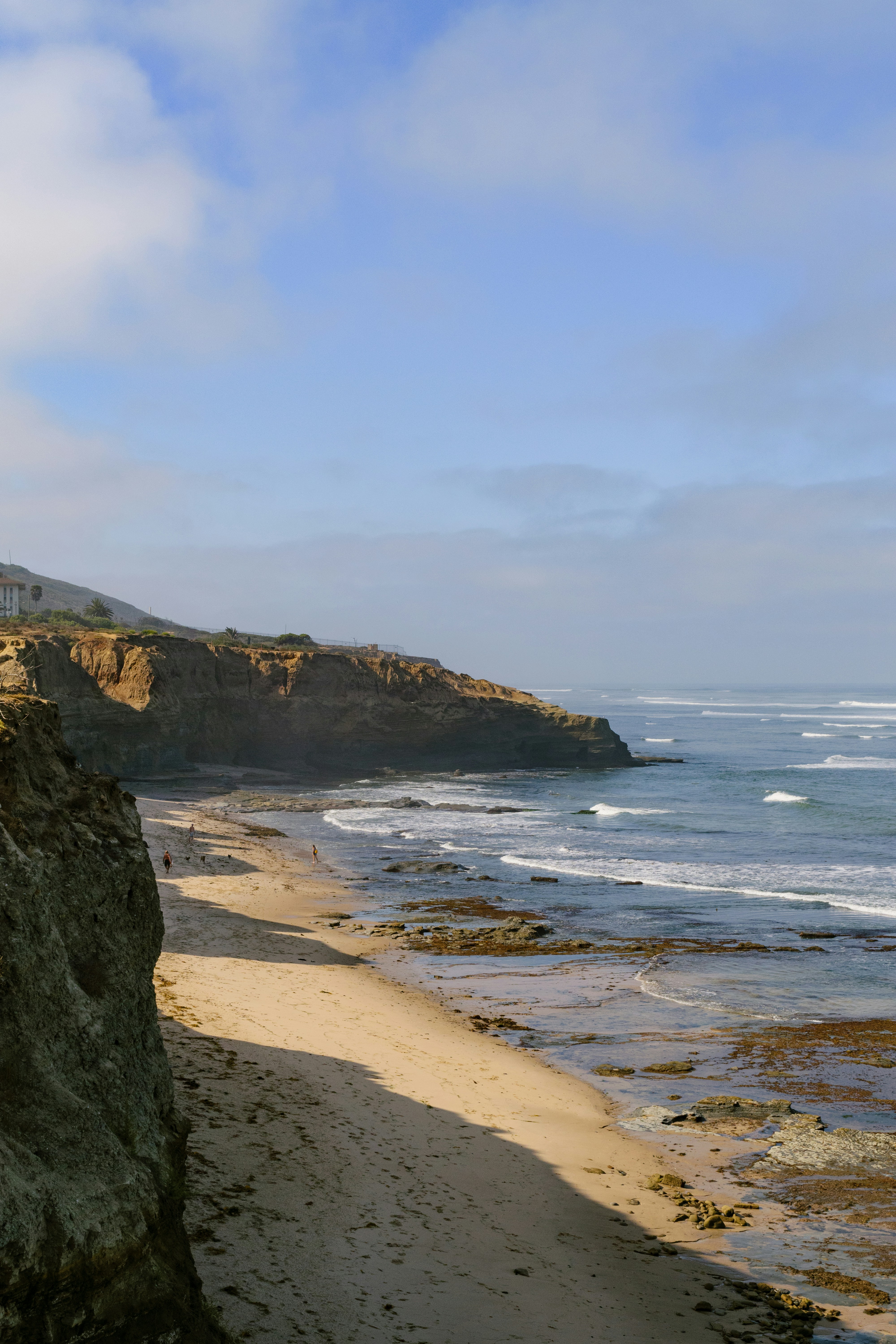 a view of a beach with a lighthouse in the distance