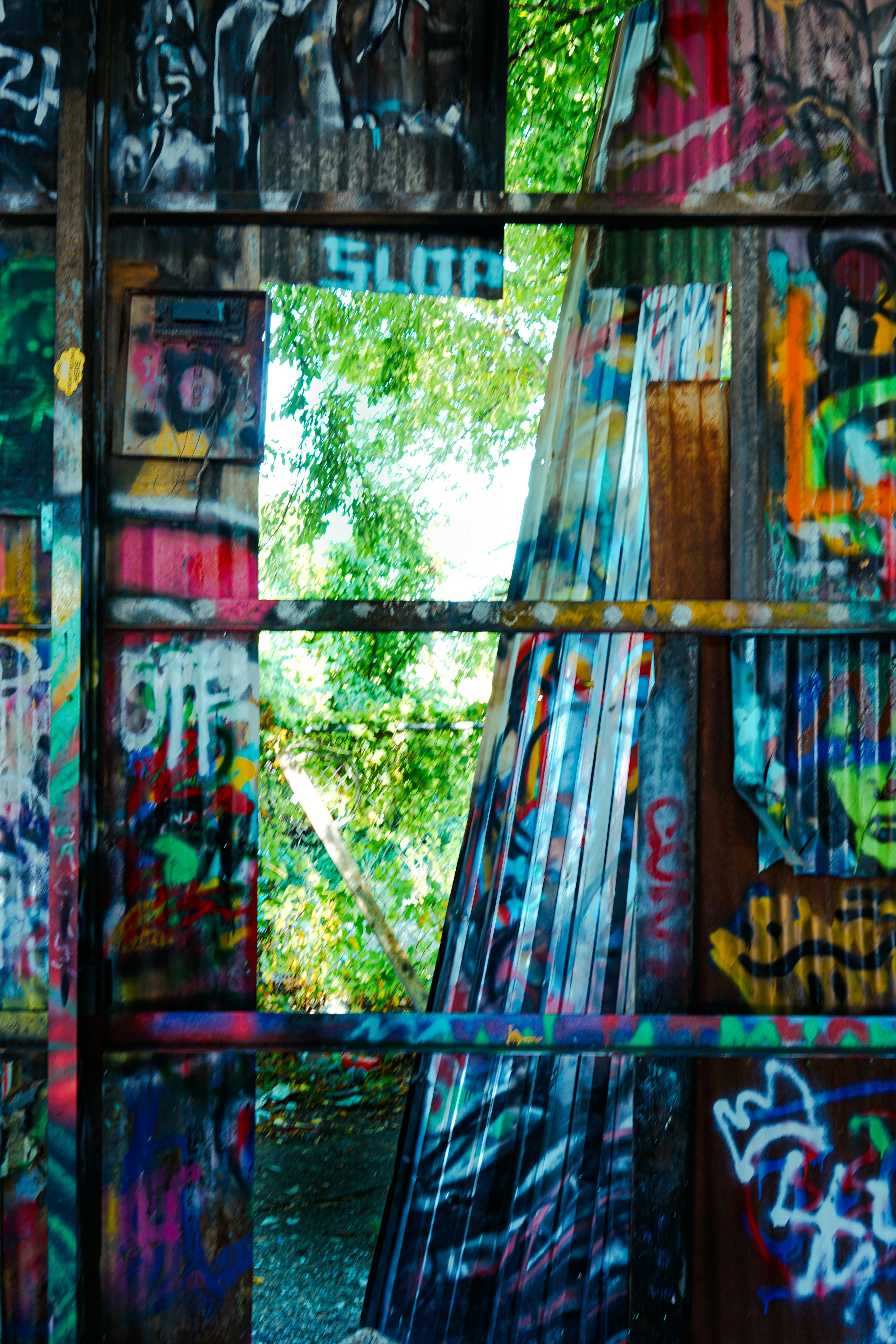 Emerald Opening: Light Through a Graffiti Corridor