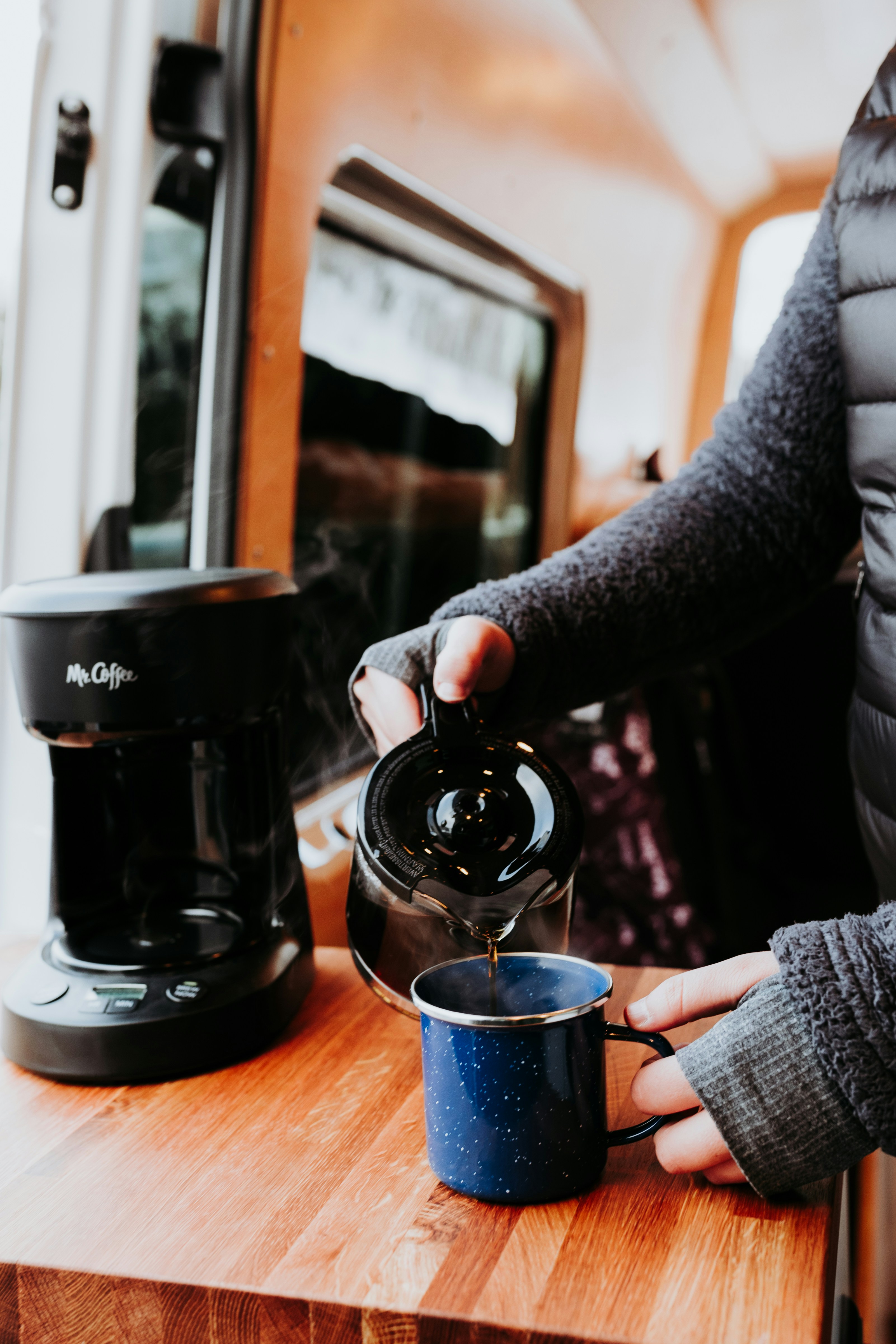 Pouring Coffee in a Cozy Camper Kitchen
