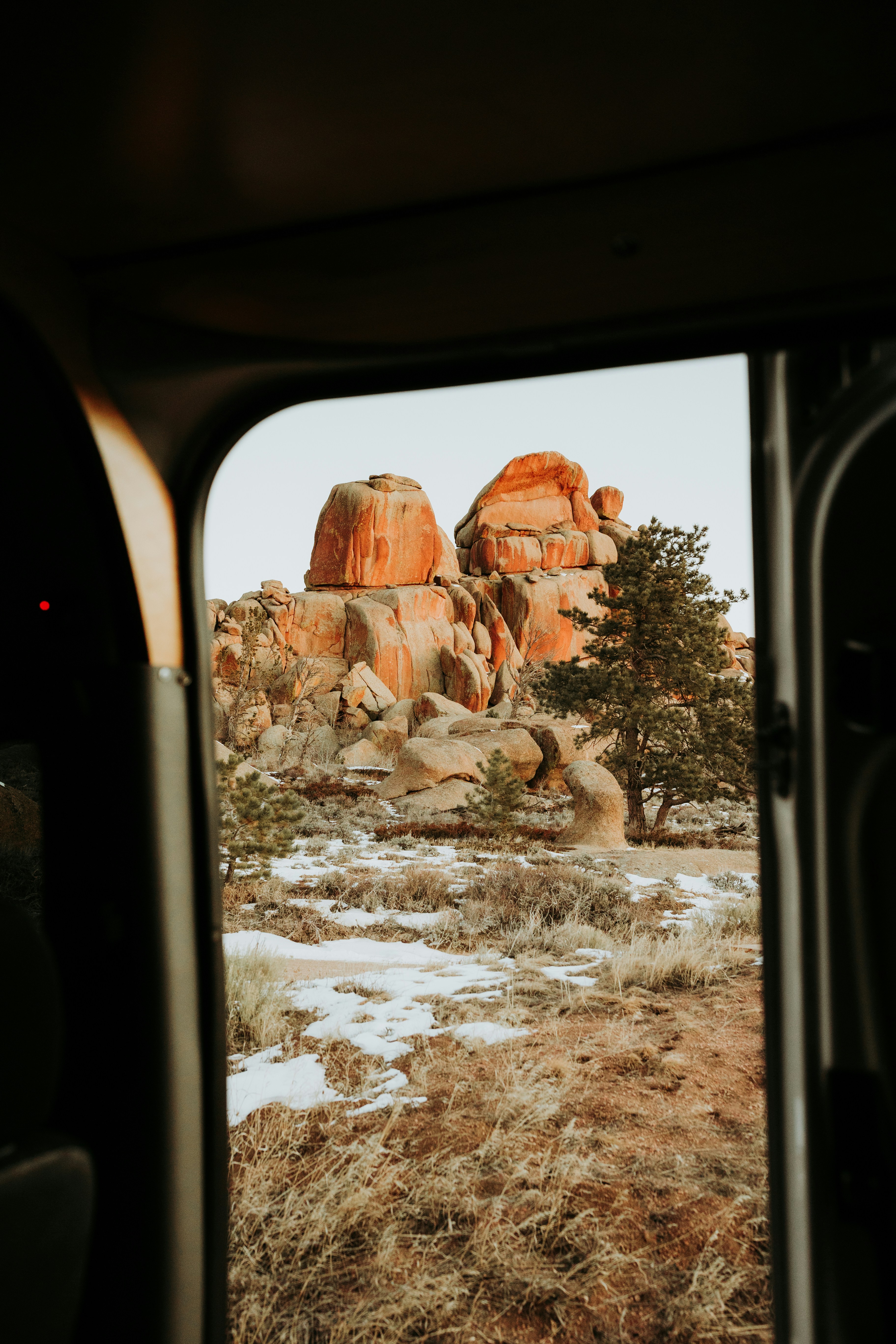 Framed Granite: Rusty Orange Rock Towers Rising Beyond a Car Window