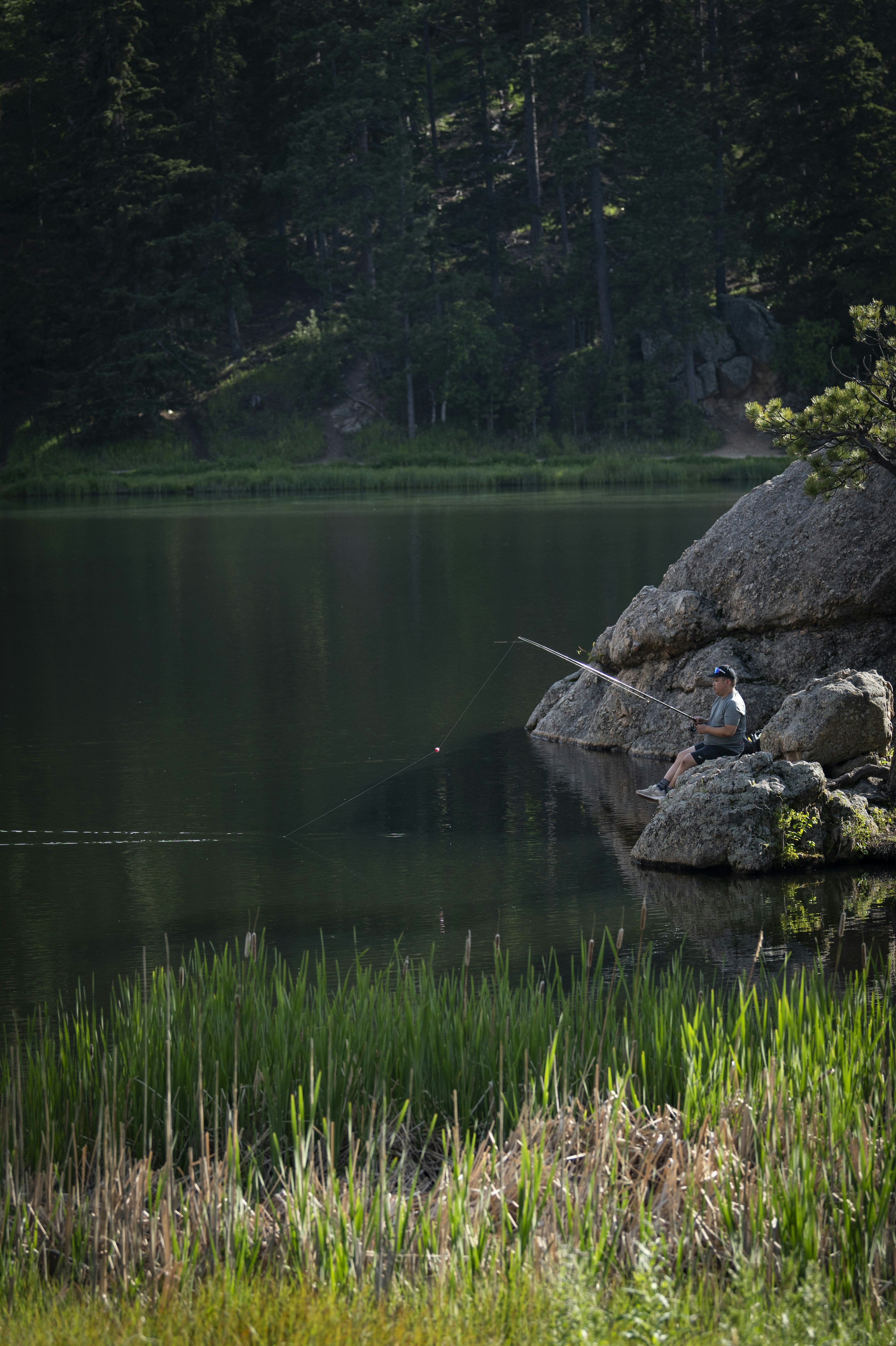 Lone Angler on the Quiet Outcrop