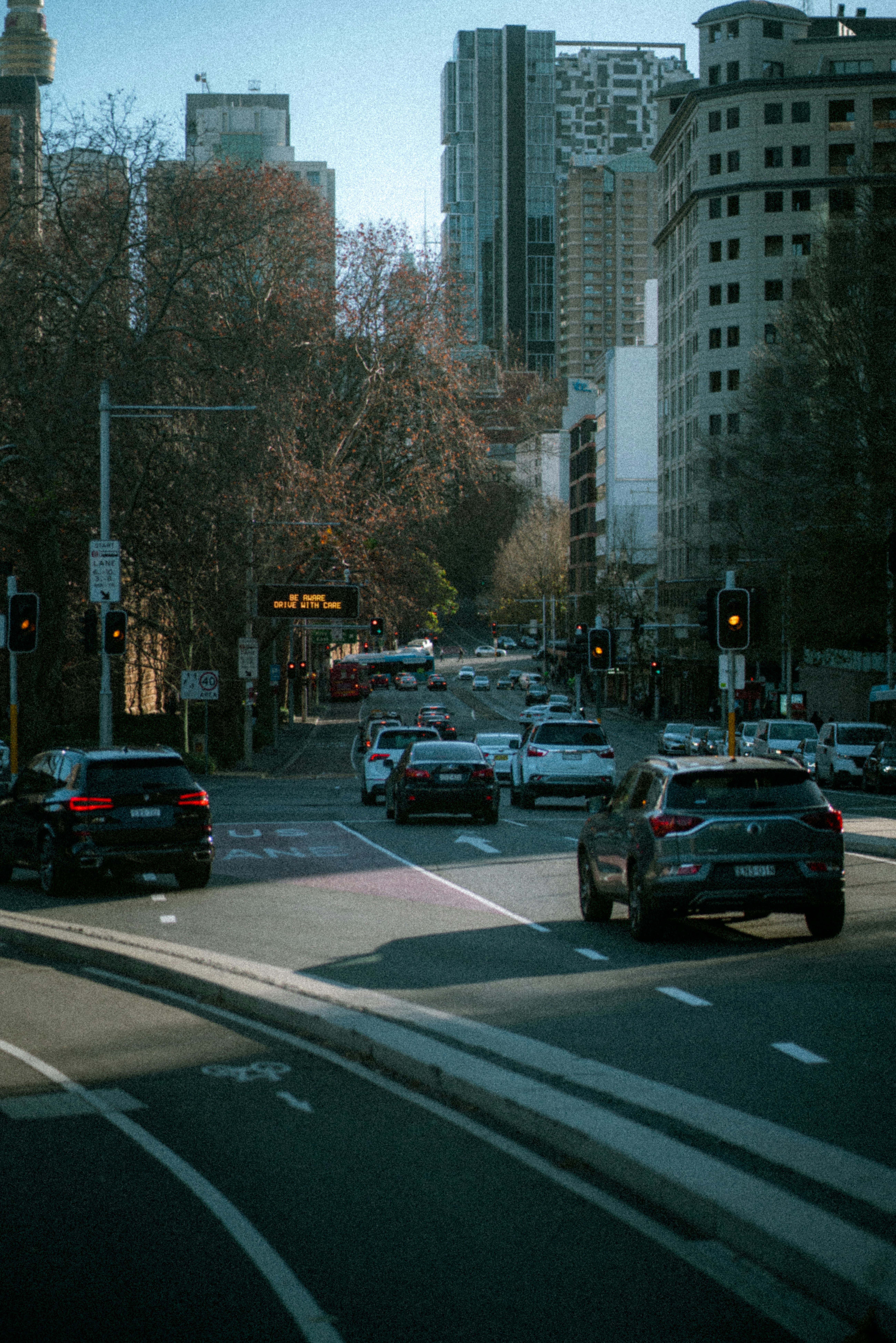 City Canyon Corridor: Morning Traffic Through a Street Framed by Towers
