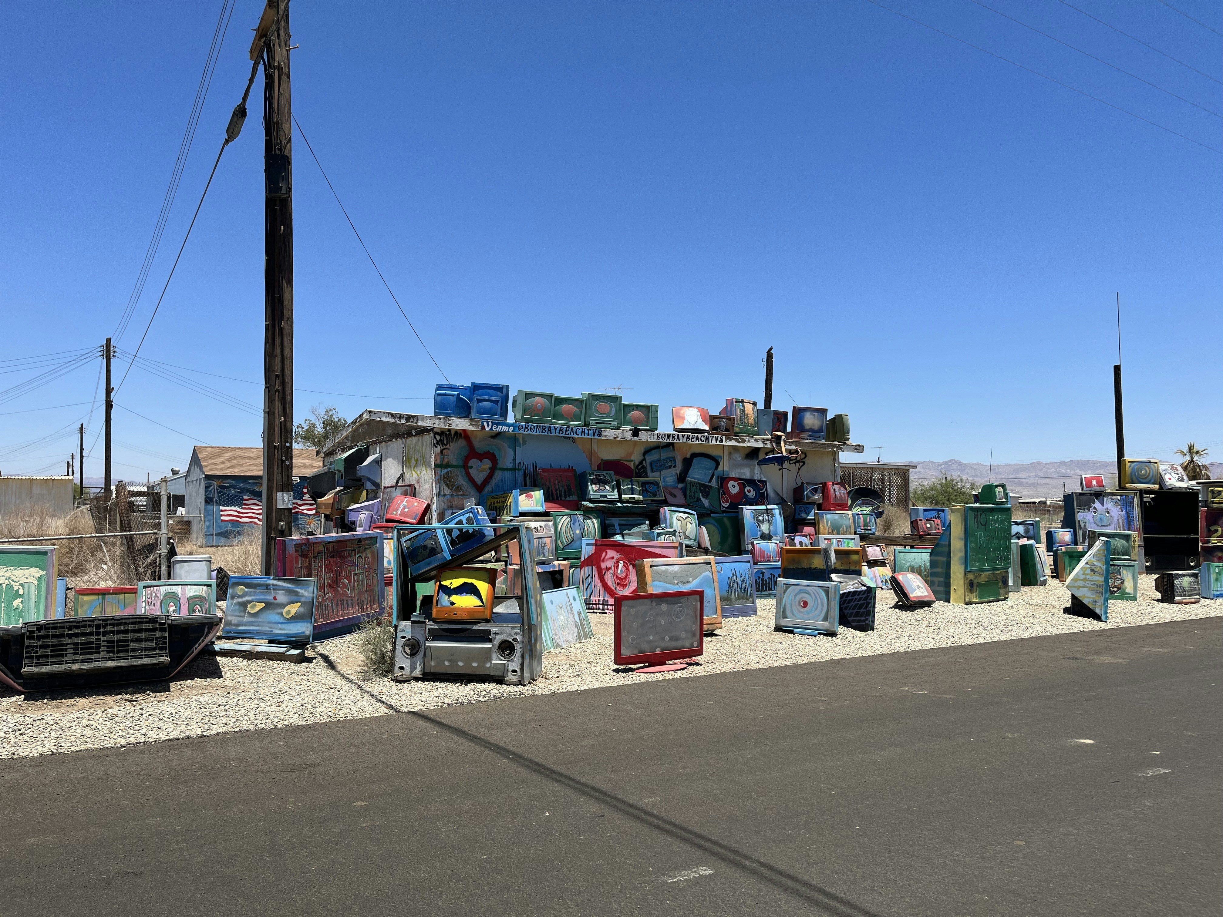 Sunlit Stack: A Desert Roadside Menagerie of Obsolete Televisions