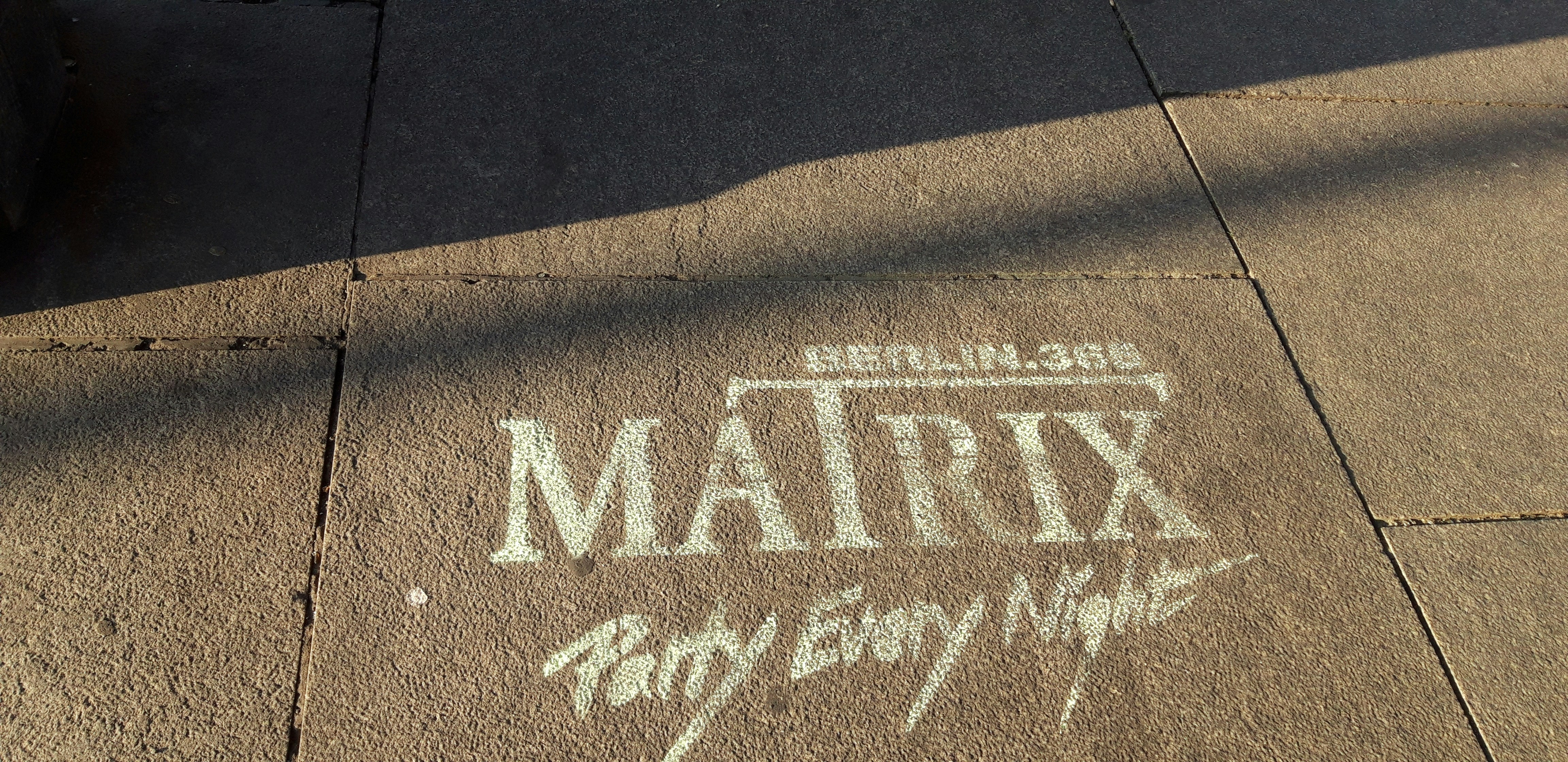Chalked MATRIX logo on a sunlit sidewalk with the cursive tagline 'Party Every Night'.