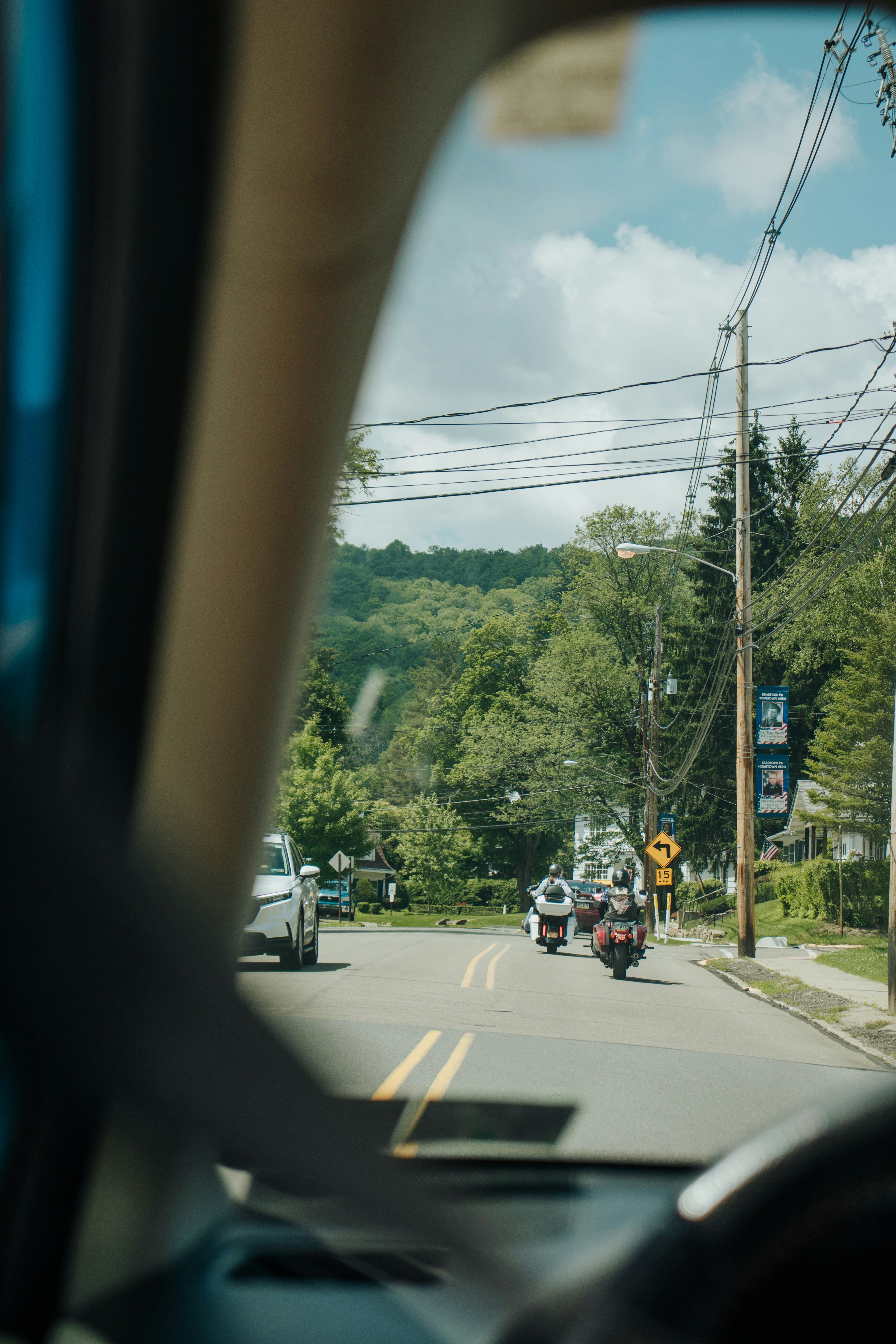 Motorcycle Convoy on a Tree-Canopied Suburban Boulevard