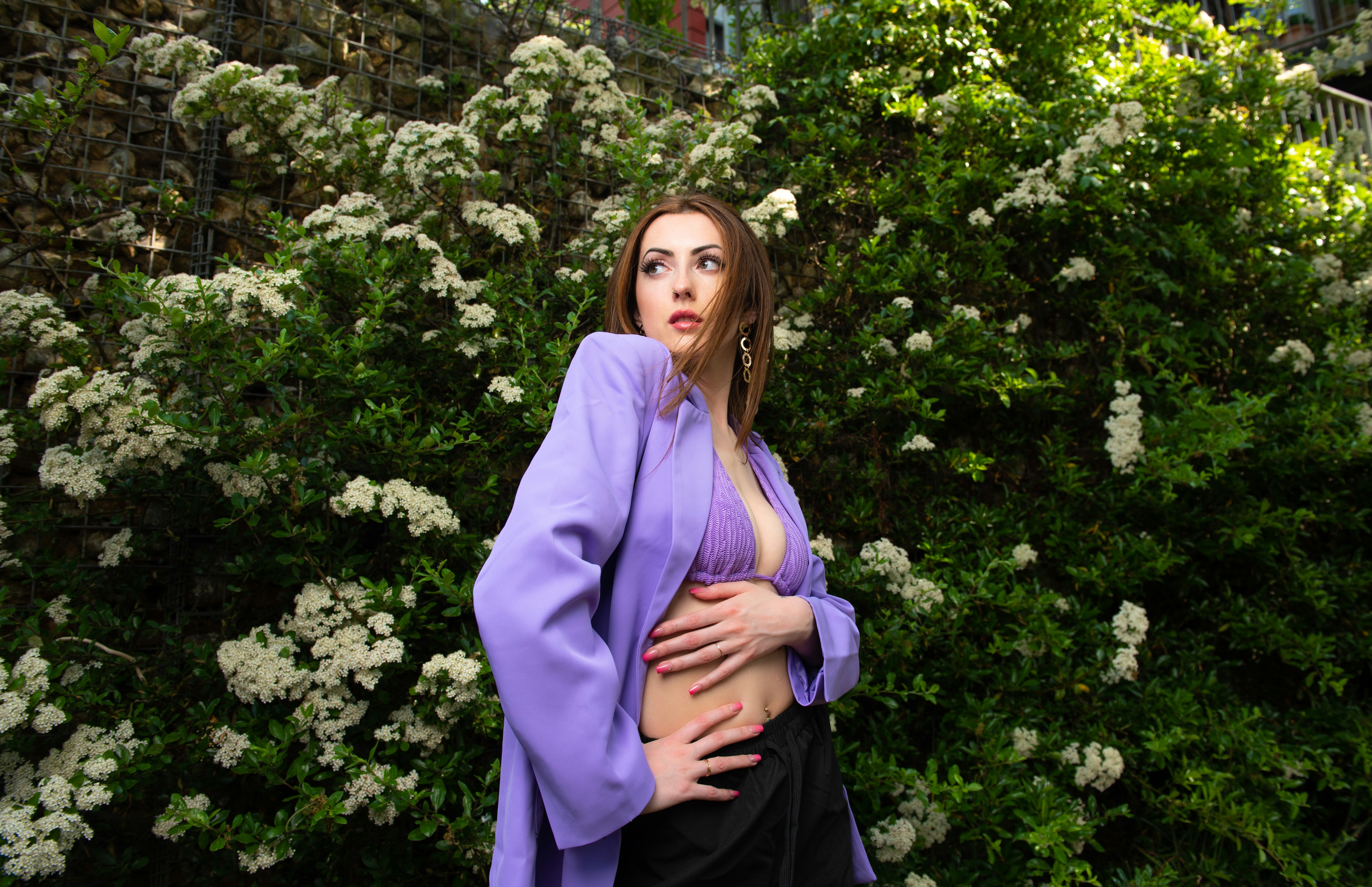 Lilac Reverie: Portrait Framed by a Blooming Hedge
