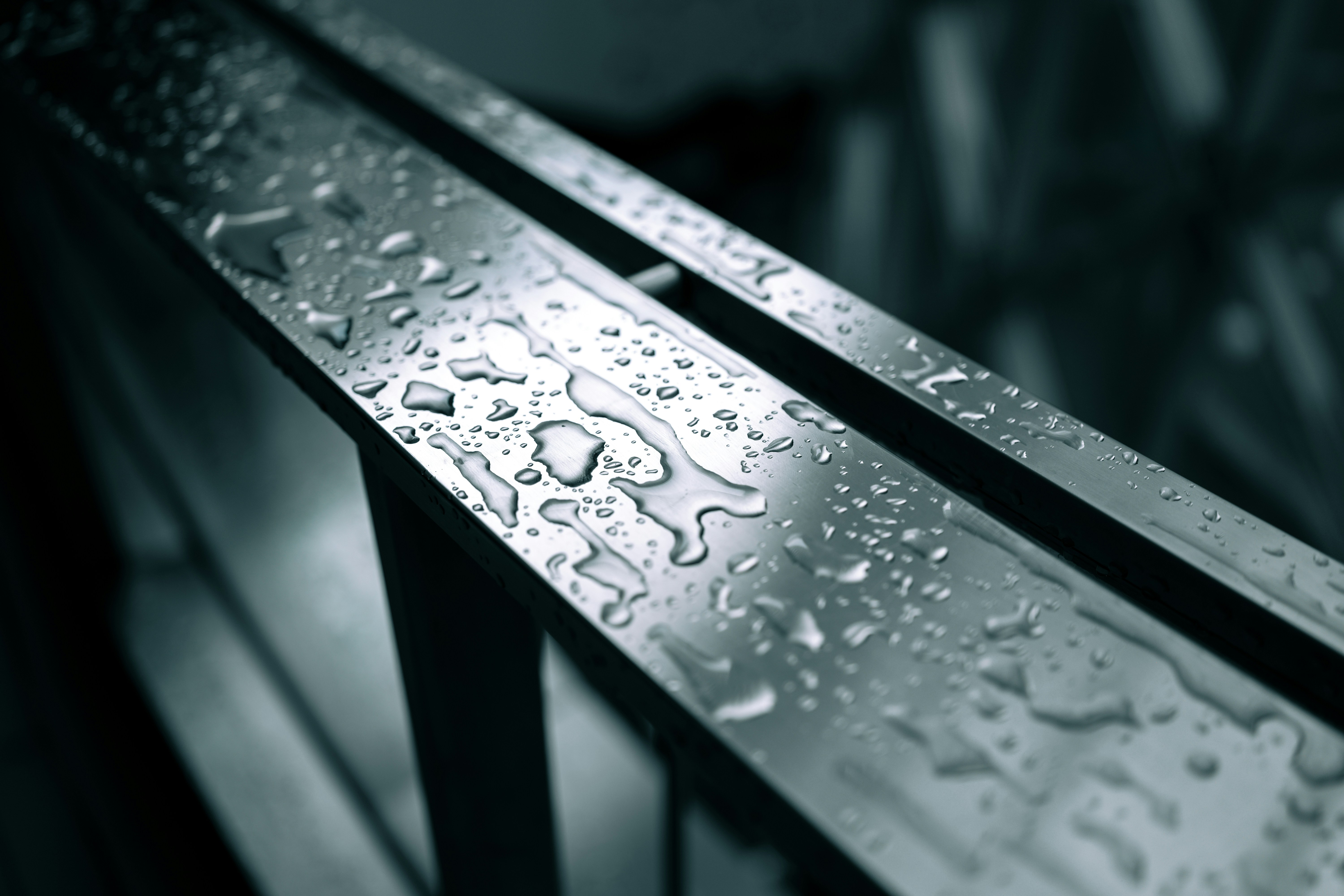 A close up of water droplets on a metal railing photo – Free The river ...