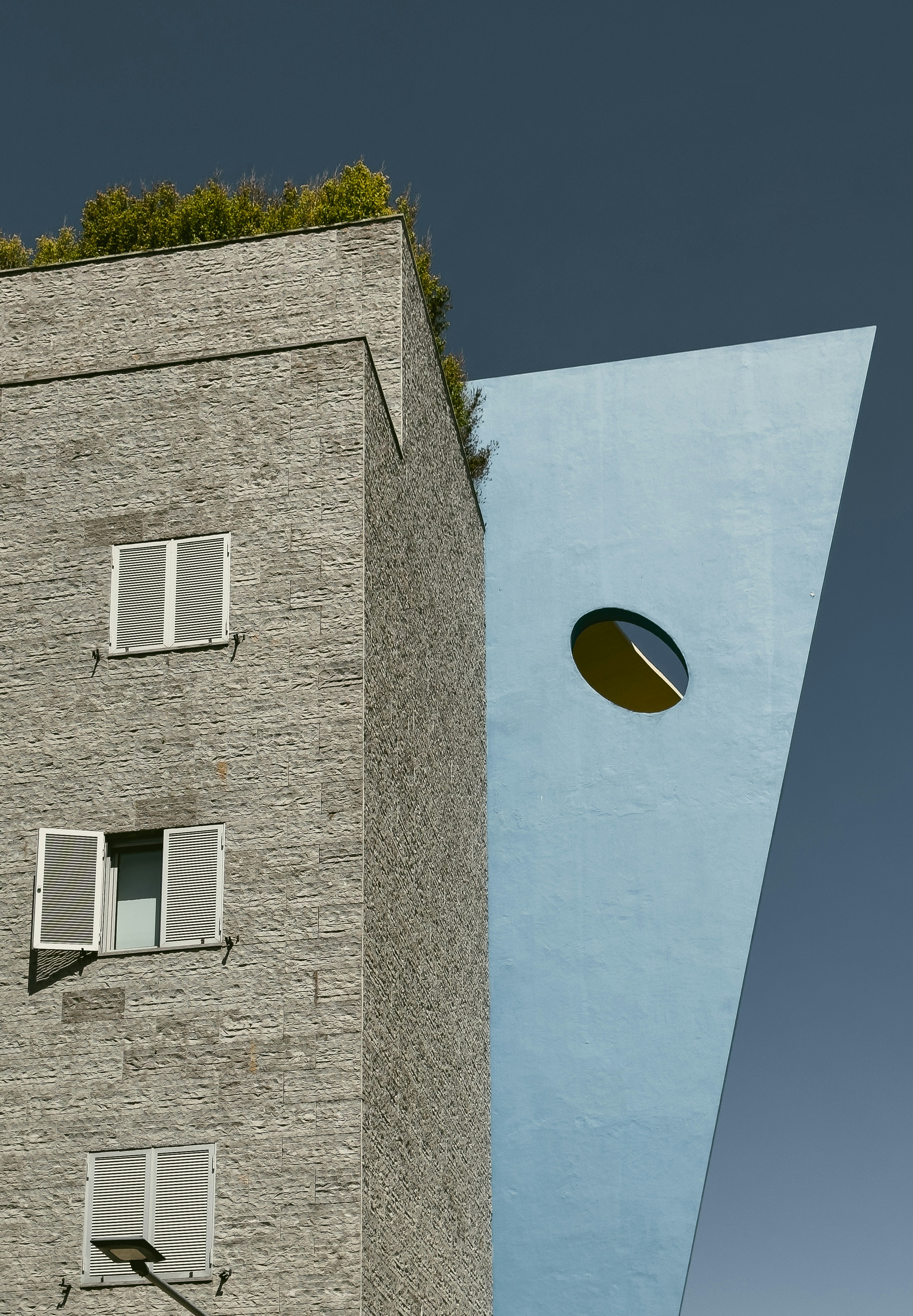 A tall blue building with a round window photo – Free Portugal Image on ...