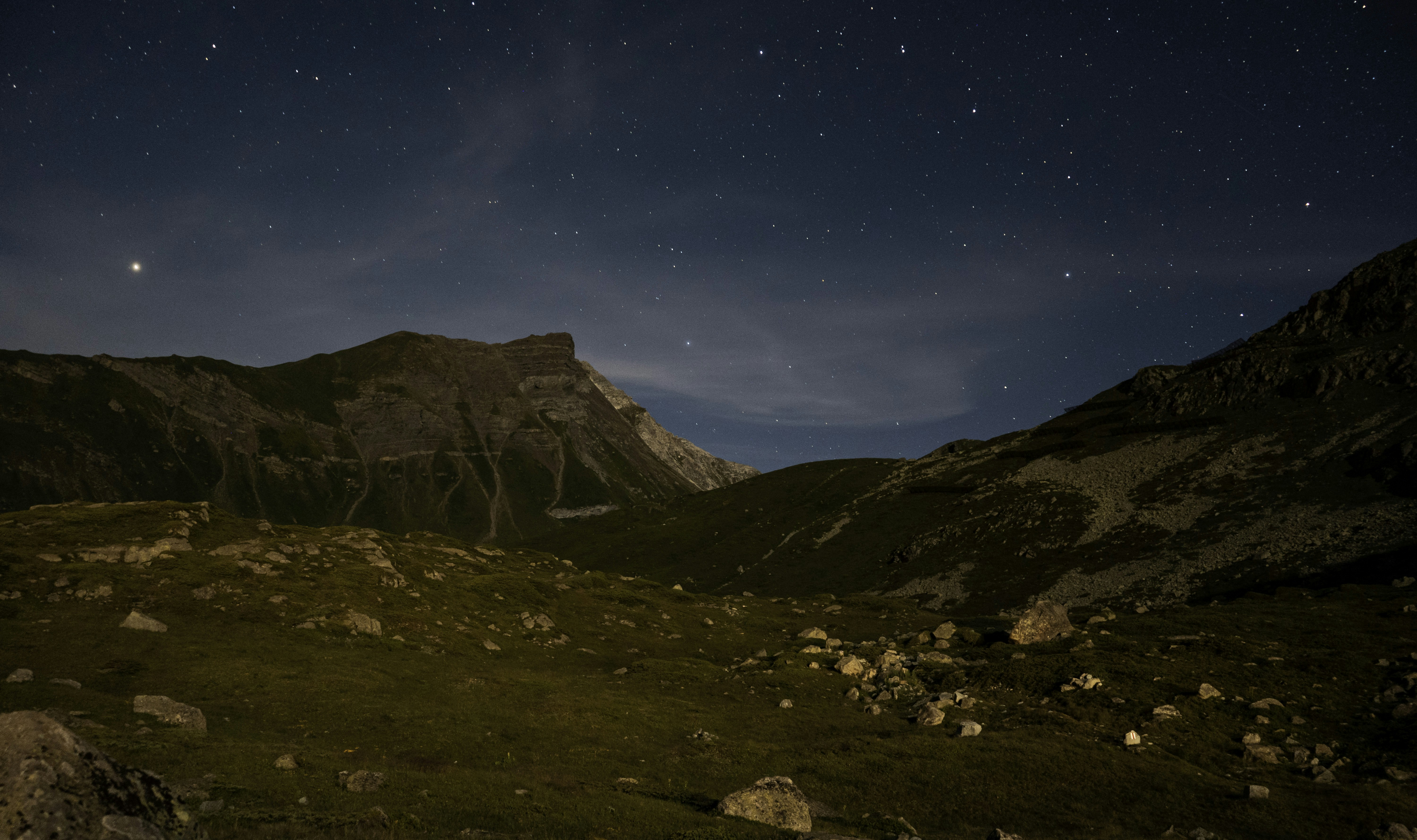 Starbound Ridge: Nightfall over a Rugged Alpine Plain
