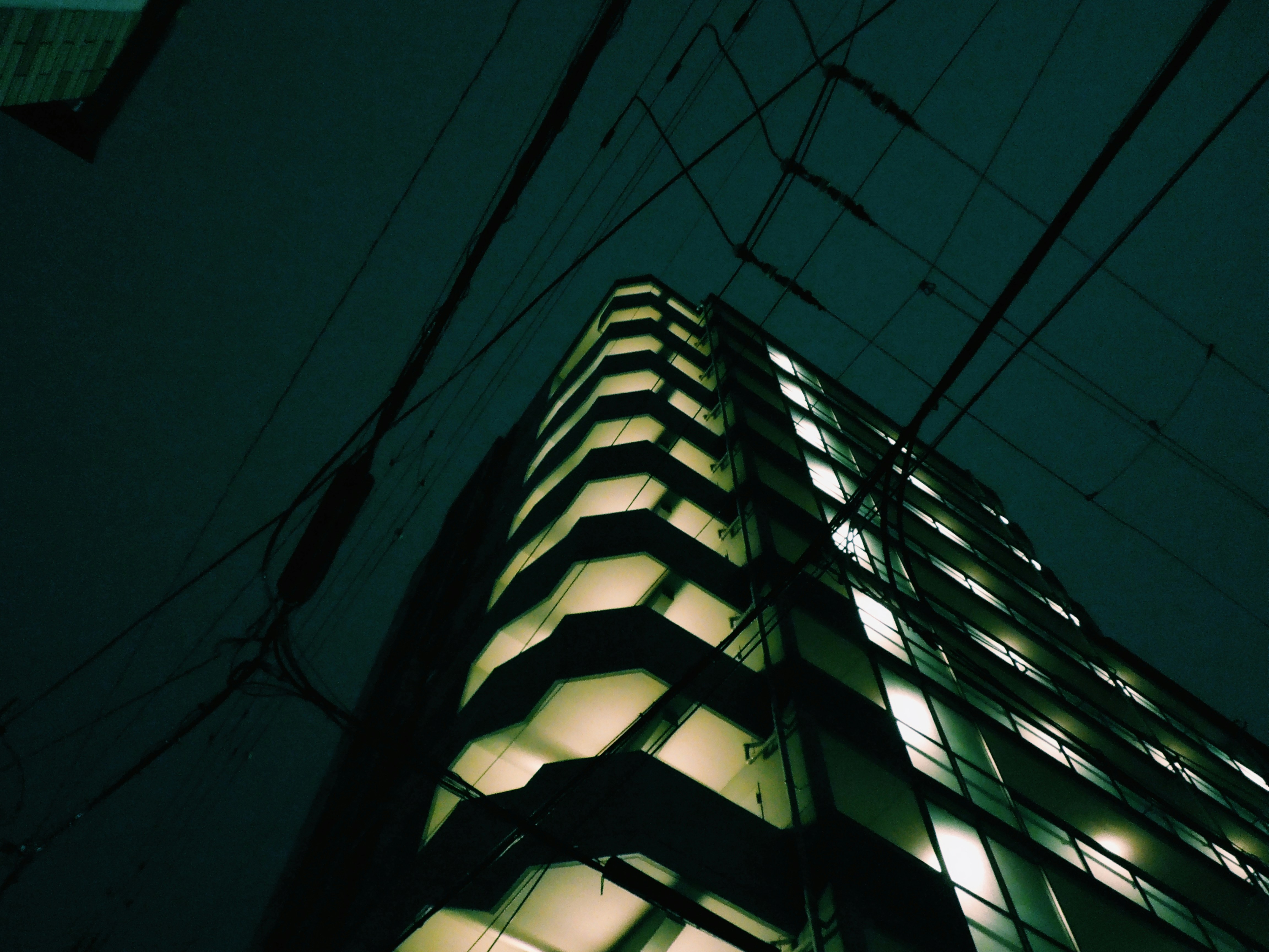 A tall building lit up at night in the dark photo – Free Tokyo Image on ...