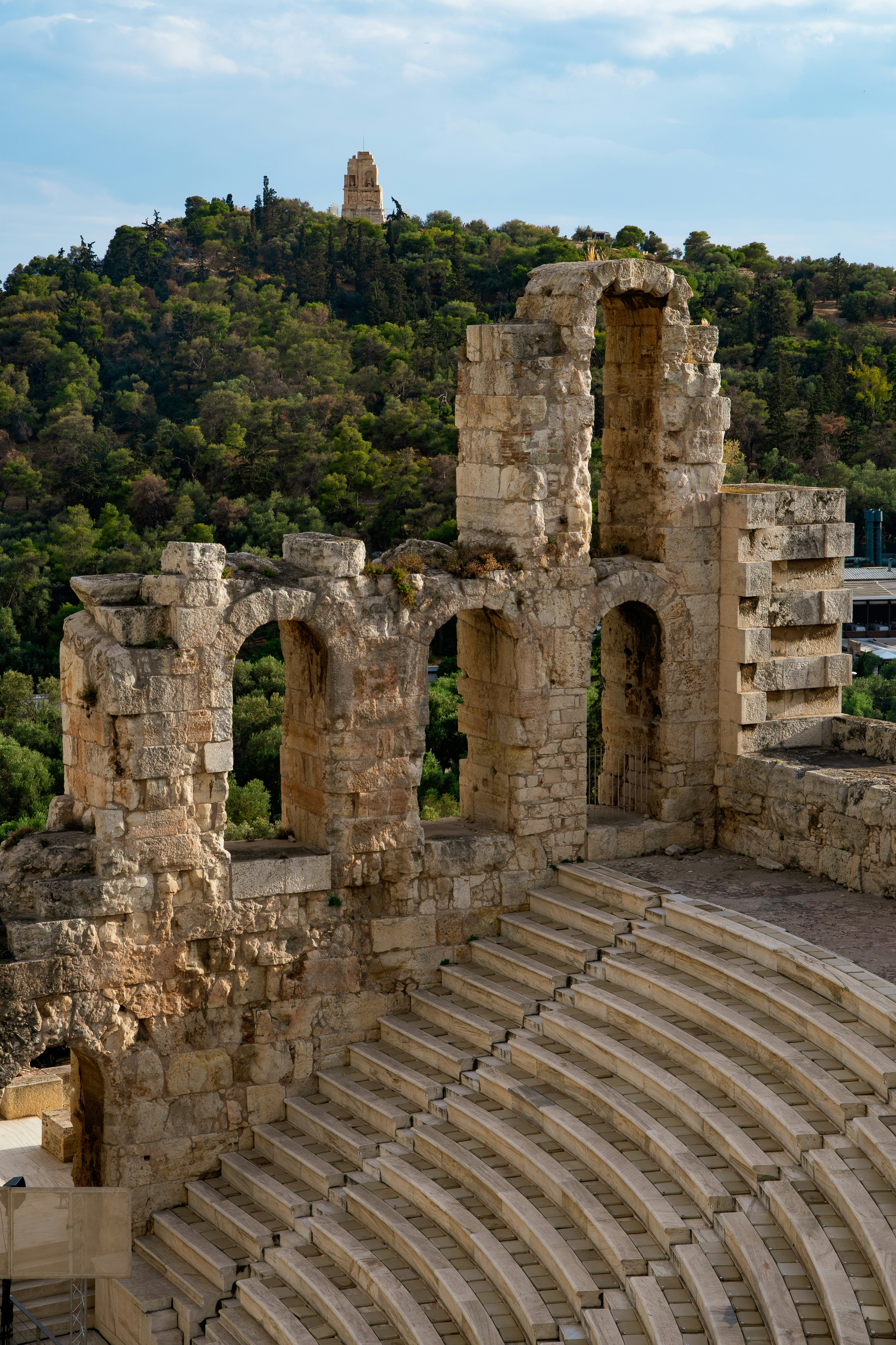 A large stone structure sitting on top of a lush green hillside photo ...