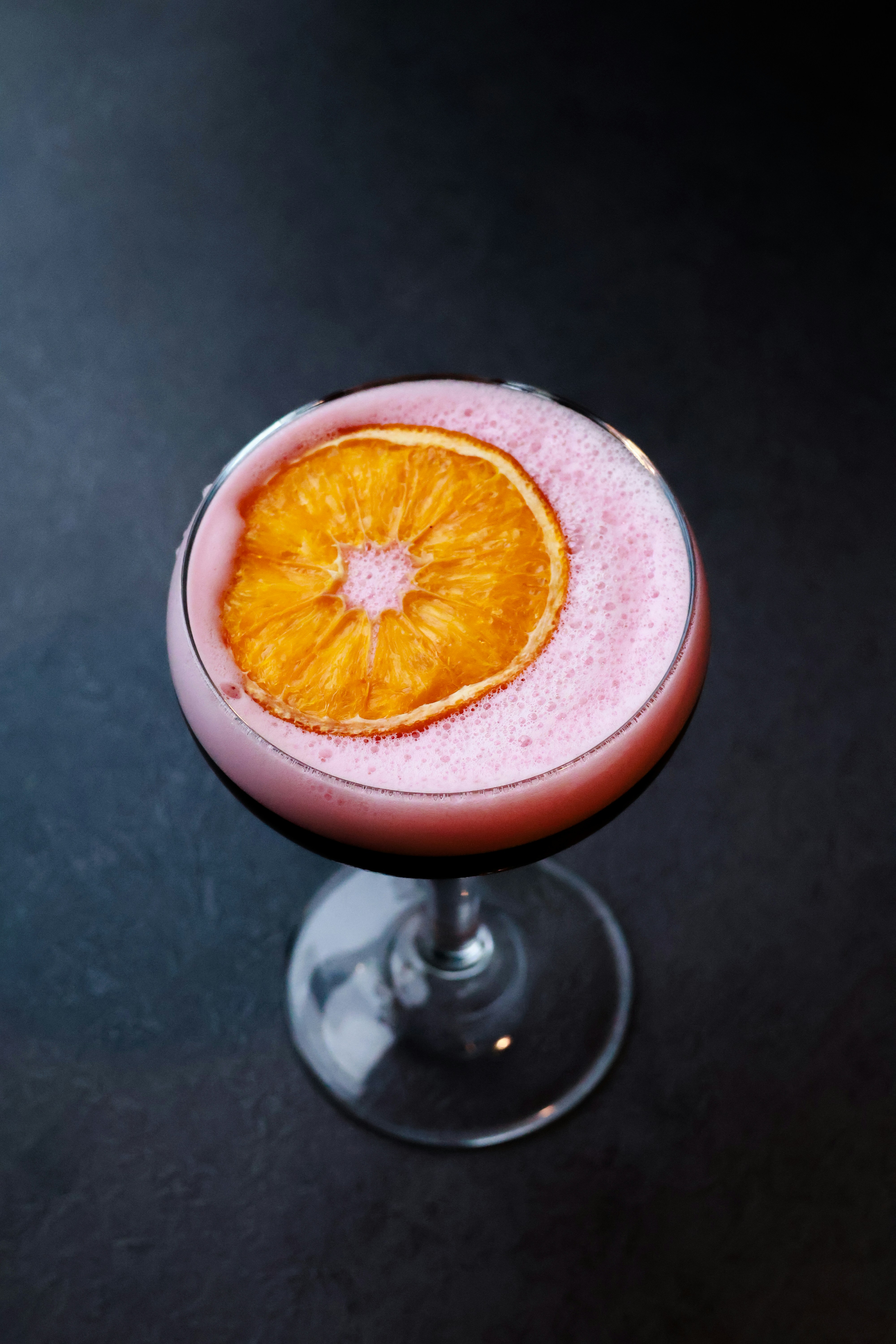 Orange Slice Spotlight on a Pink Cocktail