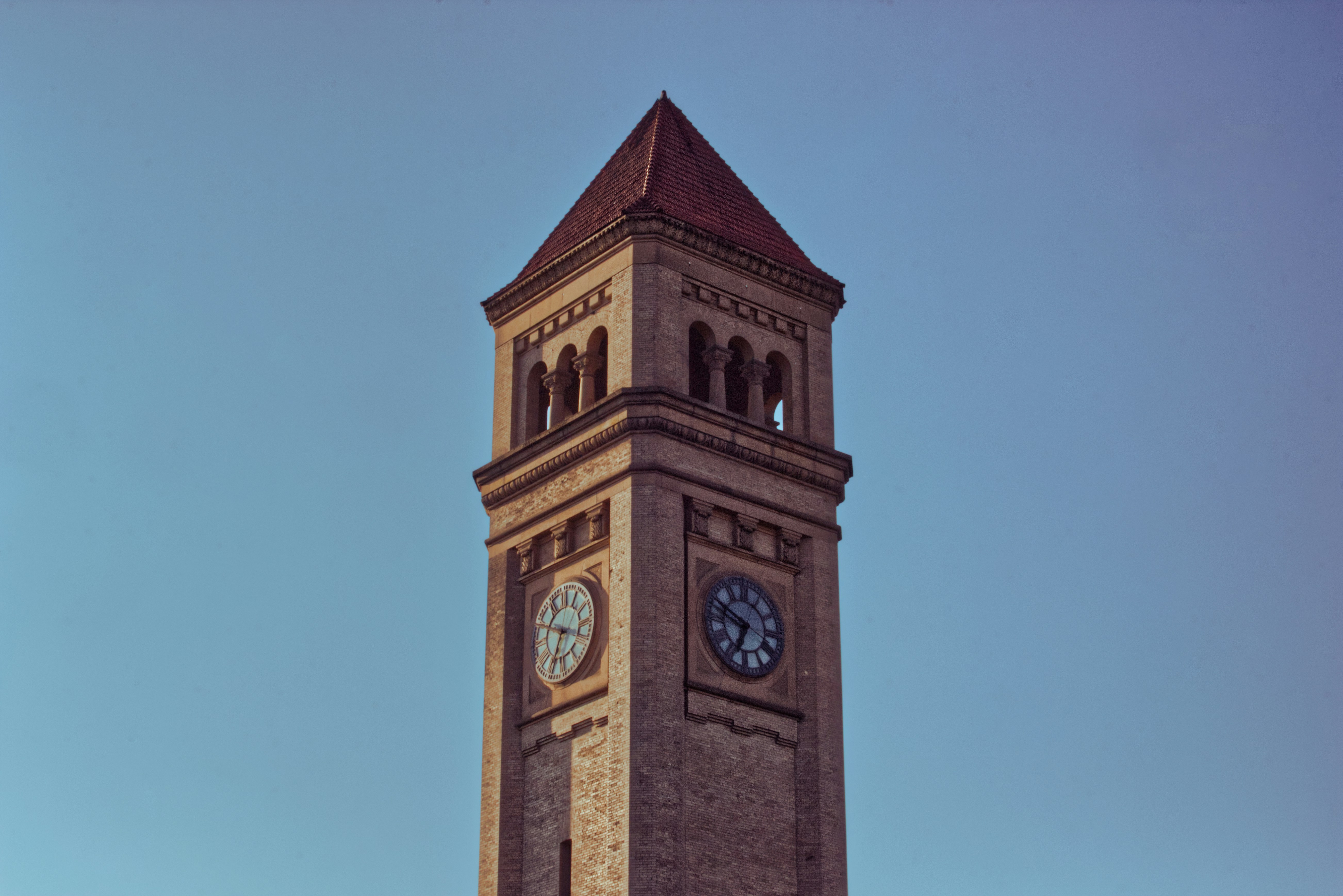 A tall clock tower with a clock on each of it's sides photo – Free ...