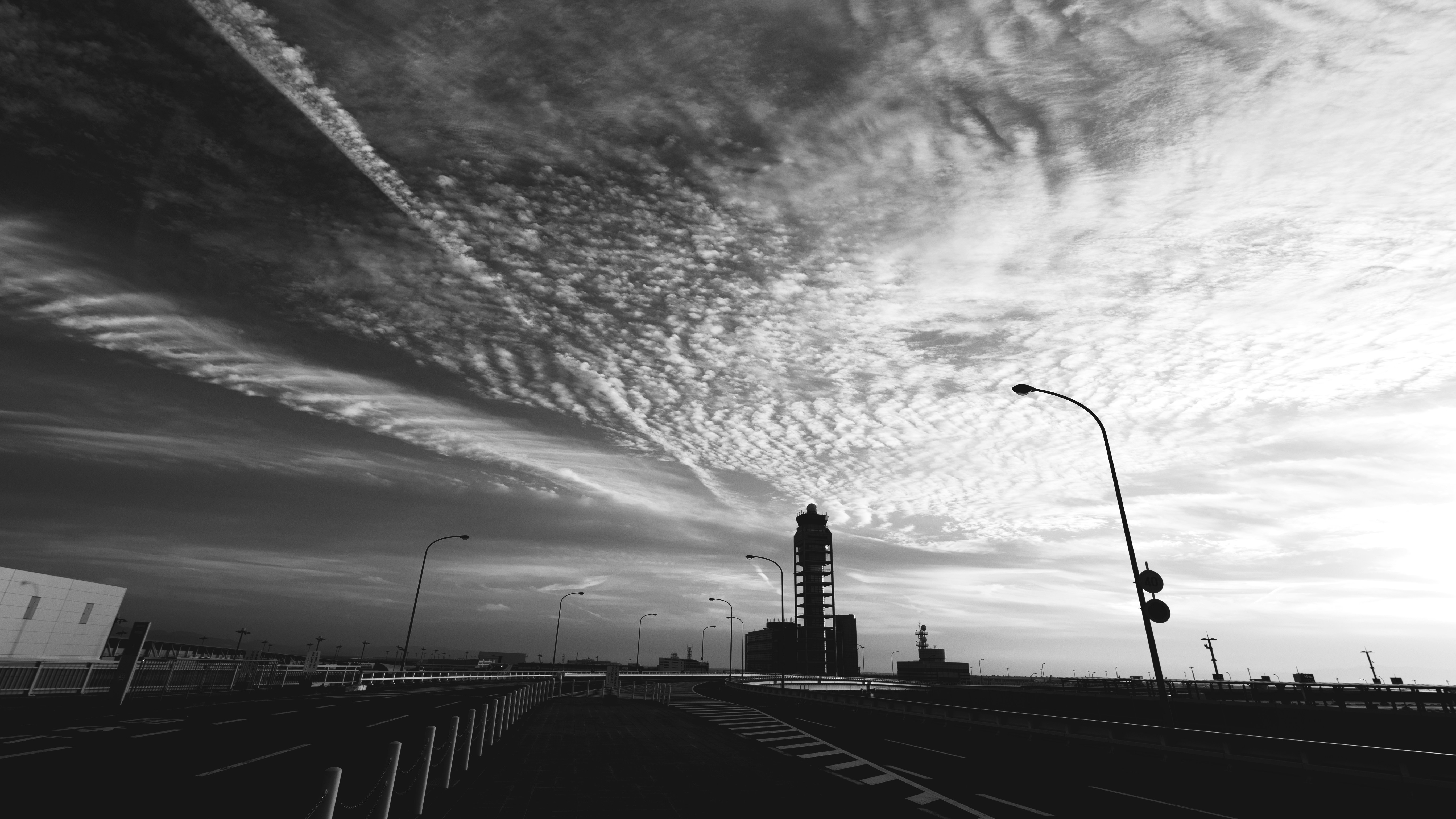 Distant Tower at Horizon: A Silent Skyline Under Striated Clouds