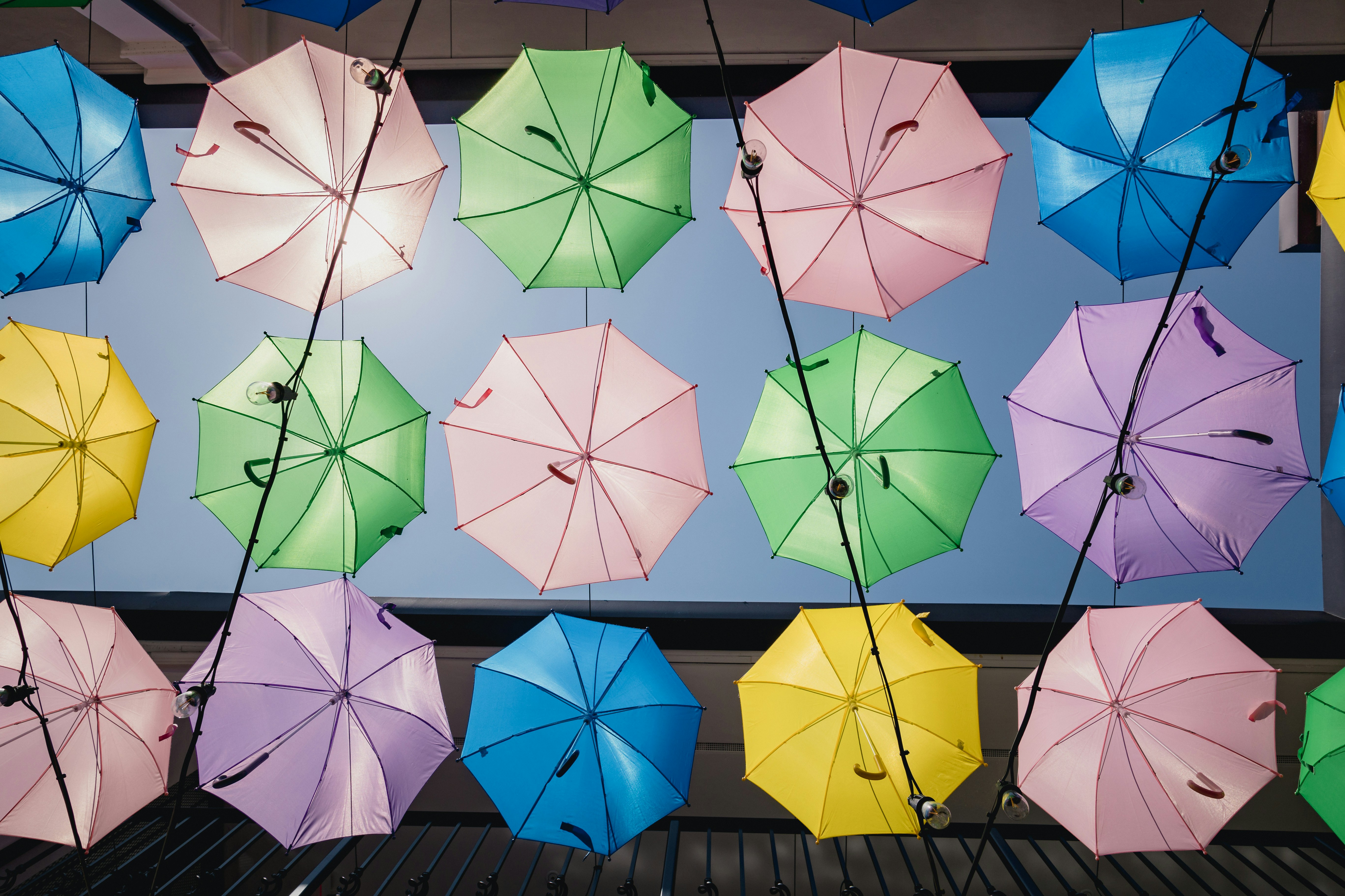 A bunch of colorful umbrellas hanging up in the air photo – Free House ...