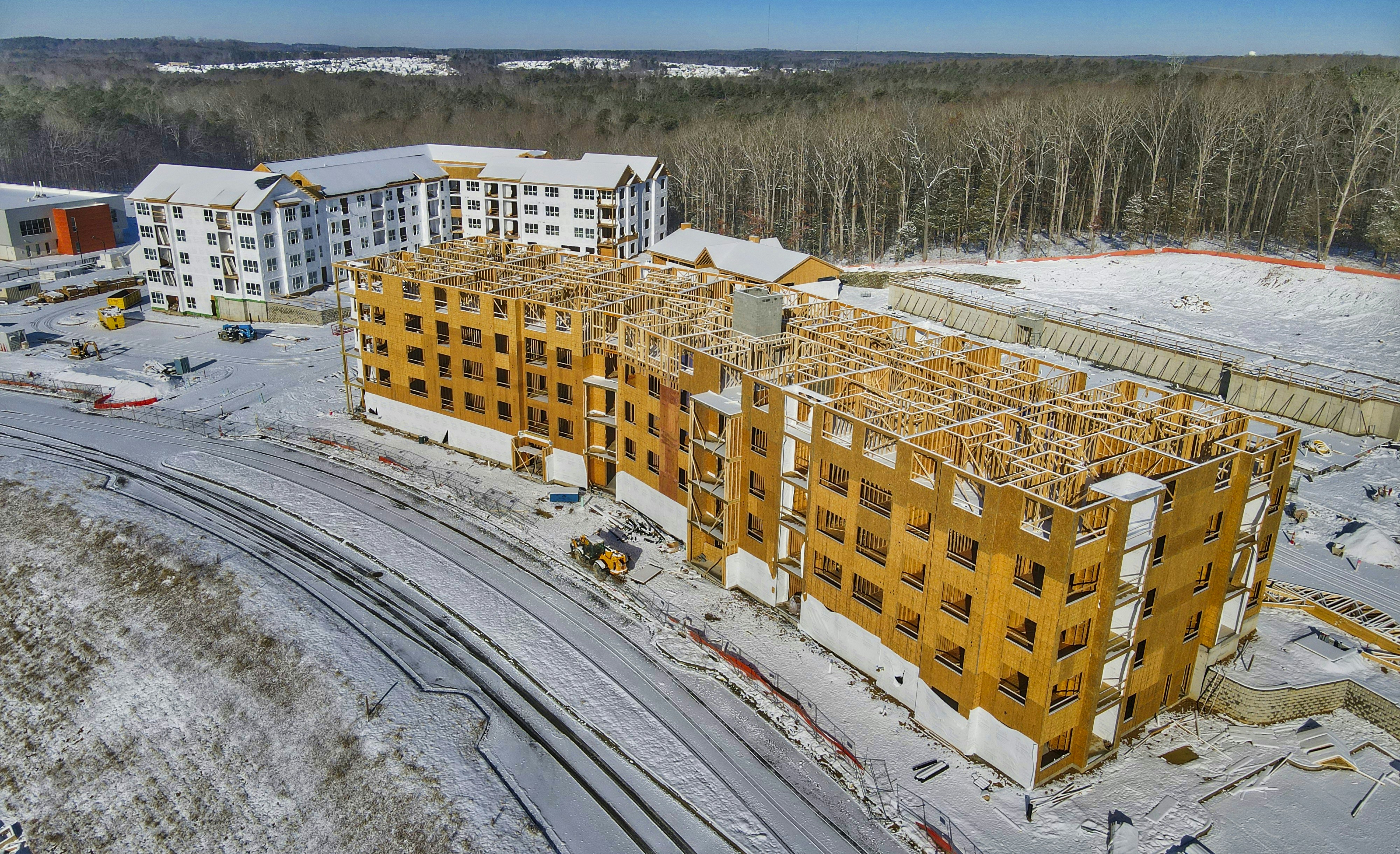 Yellow-Framed Rise: Winter Drone View of a New Apartment Block Under Construction