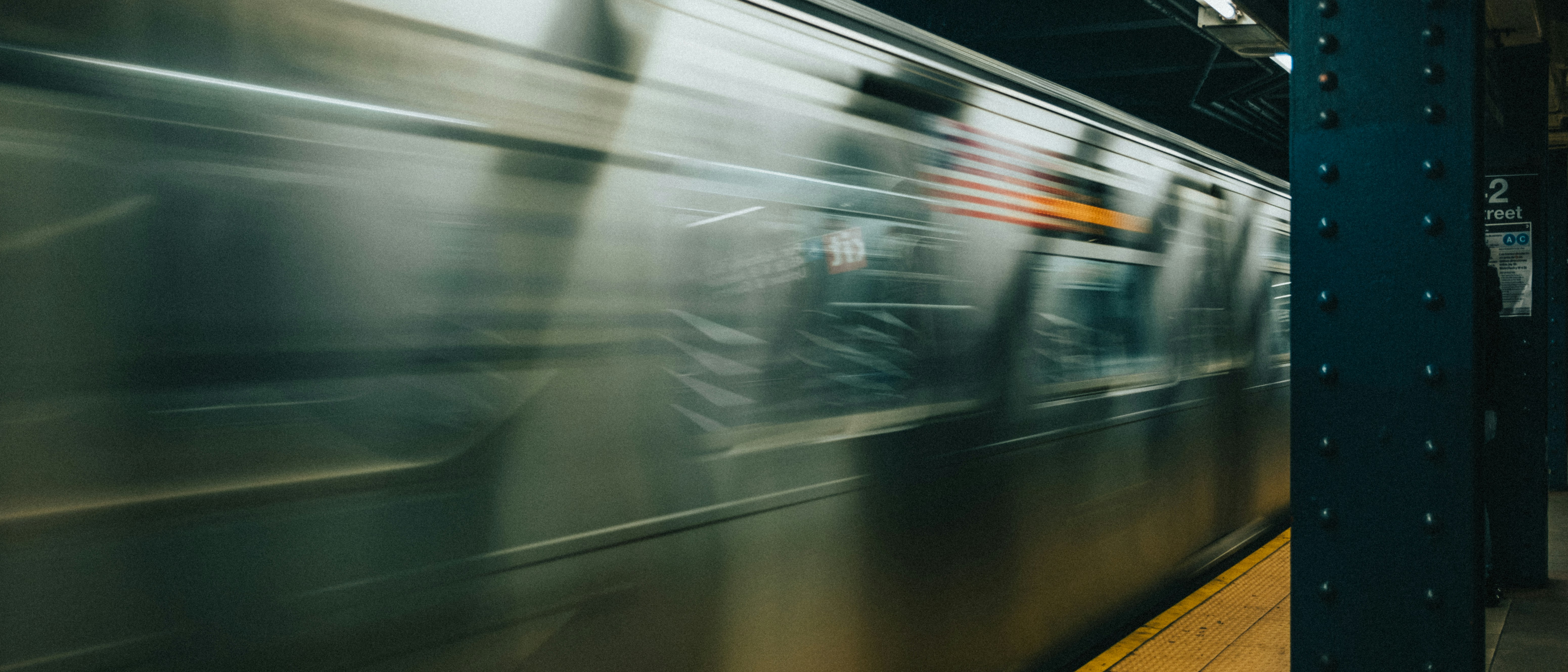 A blurry photo of a subway train speeding by photo – Free Times square ...