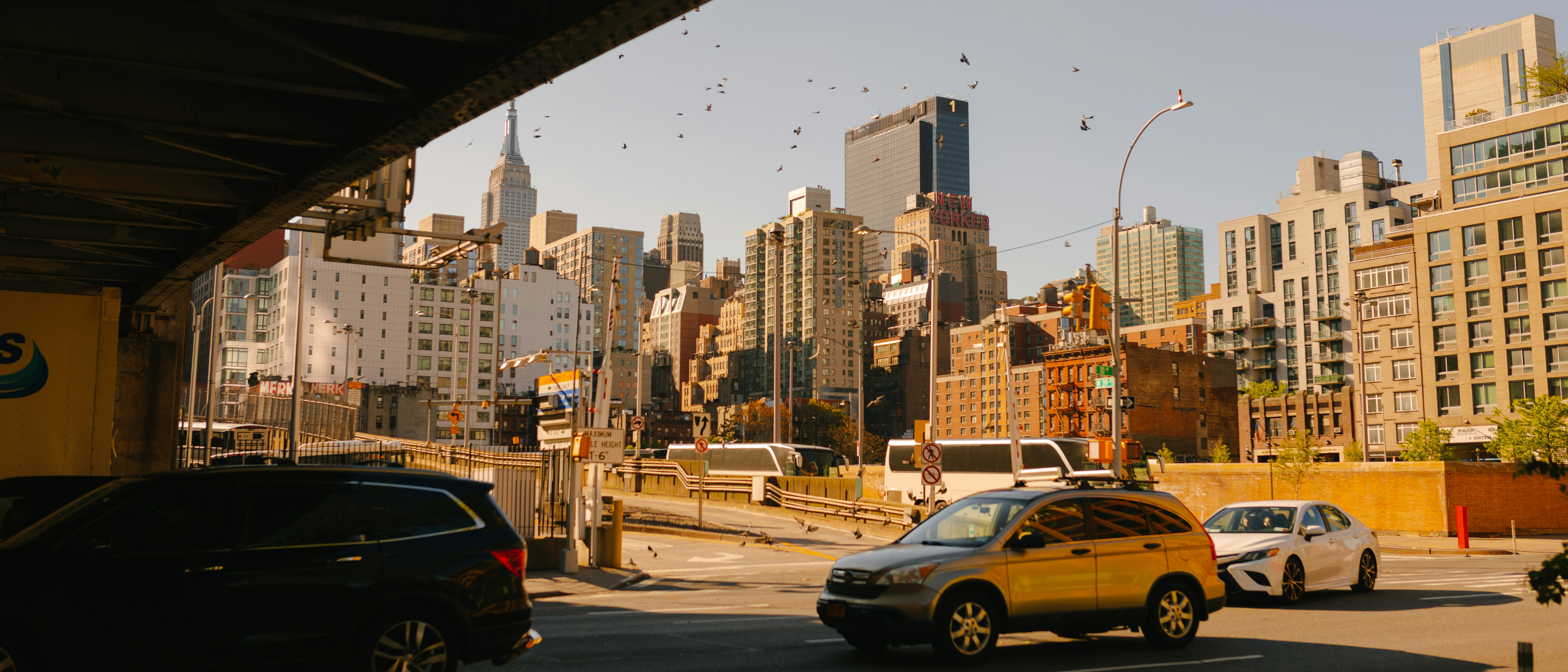 A city street filled with traffic next to tall buildings photo – Free ...