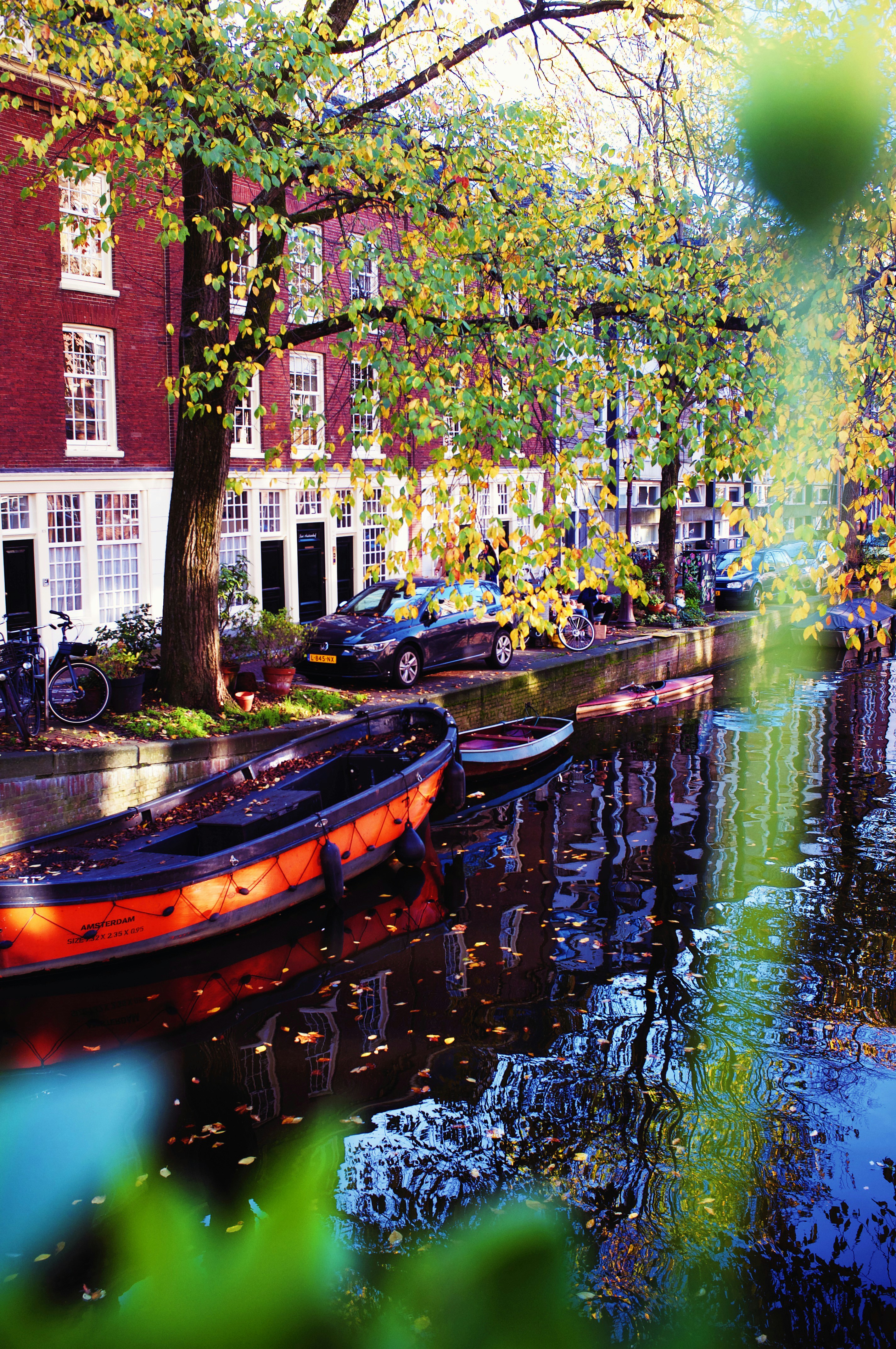 Amber Canalside: Boats, Brick Facades, and Autumn Reflections